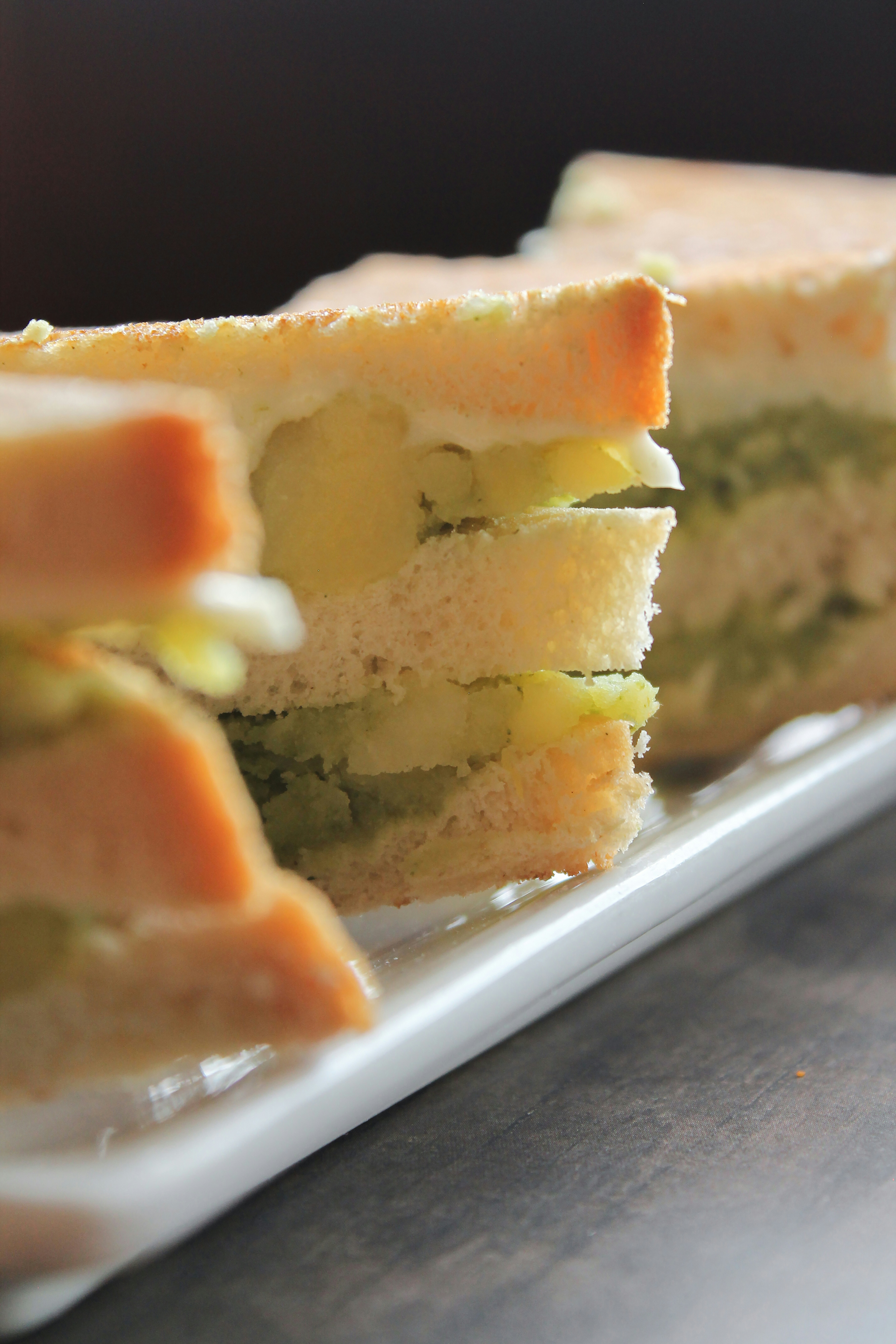 Stacked Delicacy: Close-Up of Colorful Sandwich Slices on a Plate