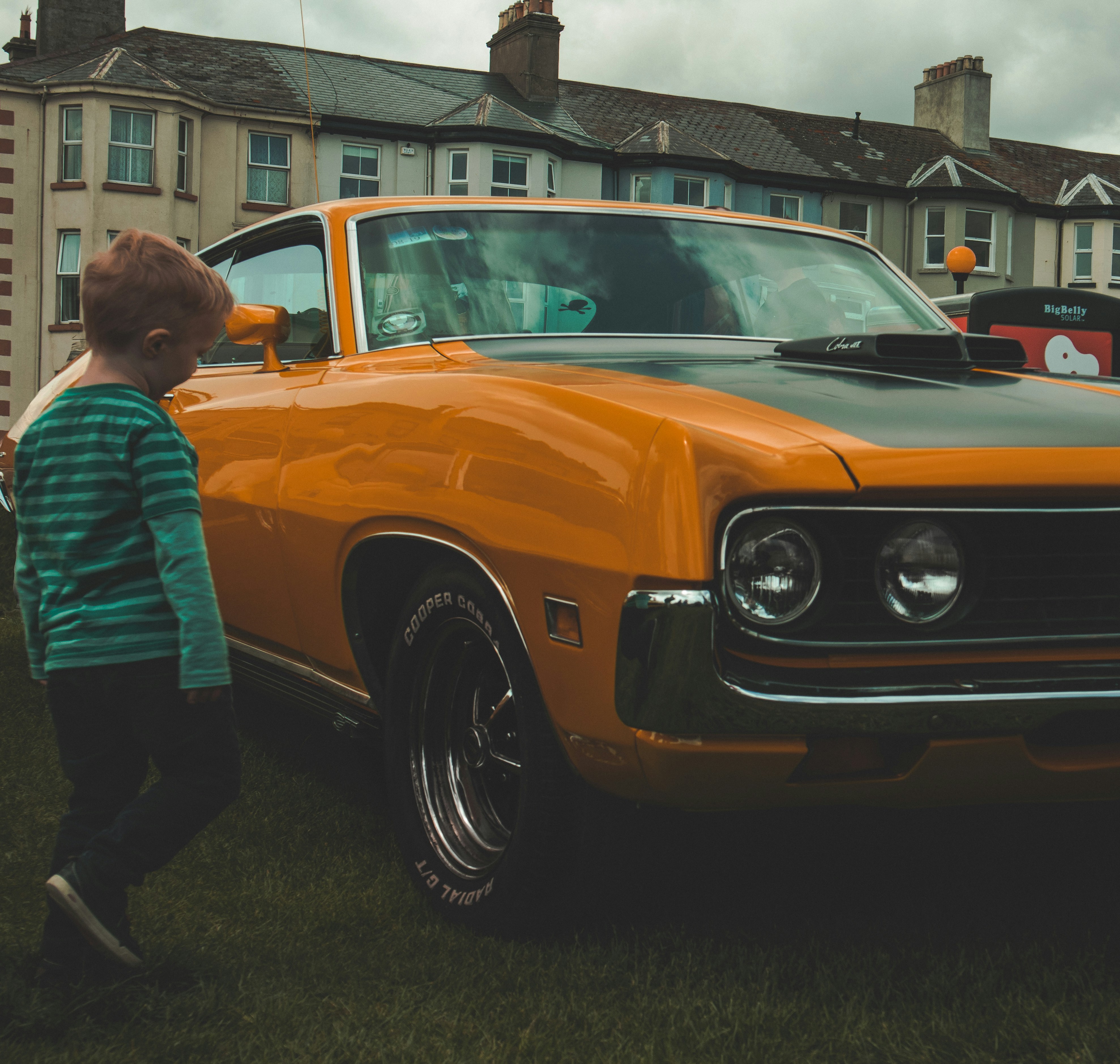 Lawnside Thunder: A Vintage Orange Chevelle Anchors a Quiet Suburban Afternoon