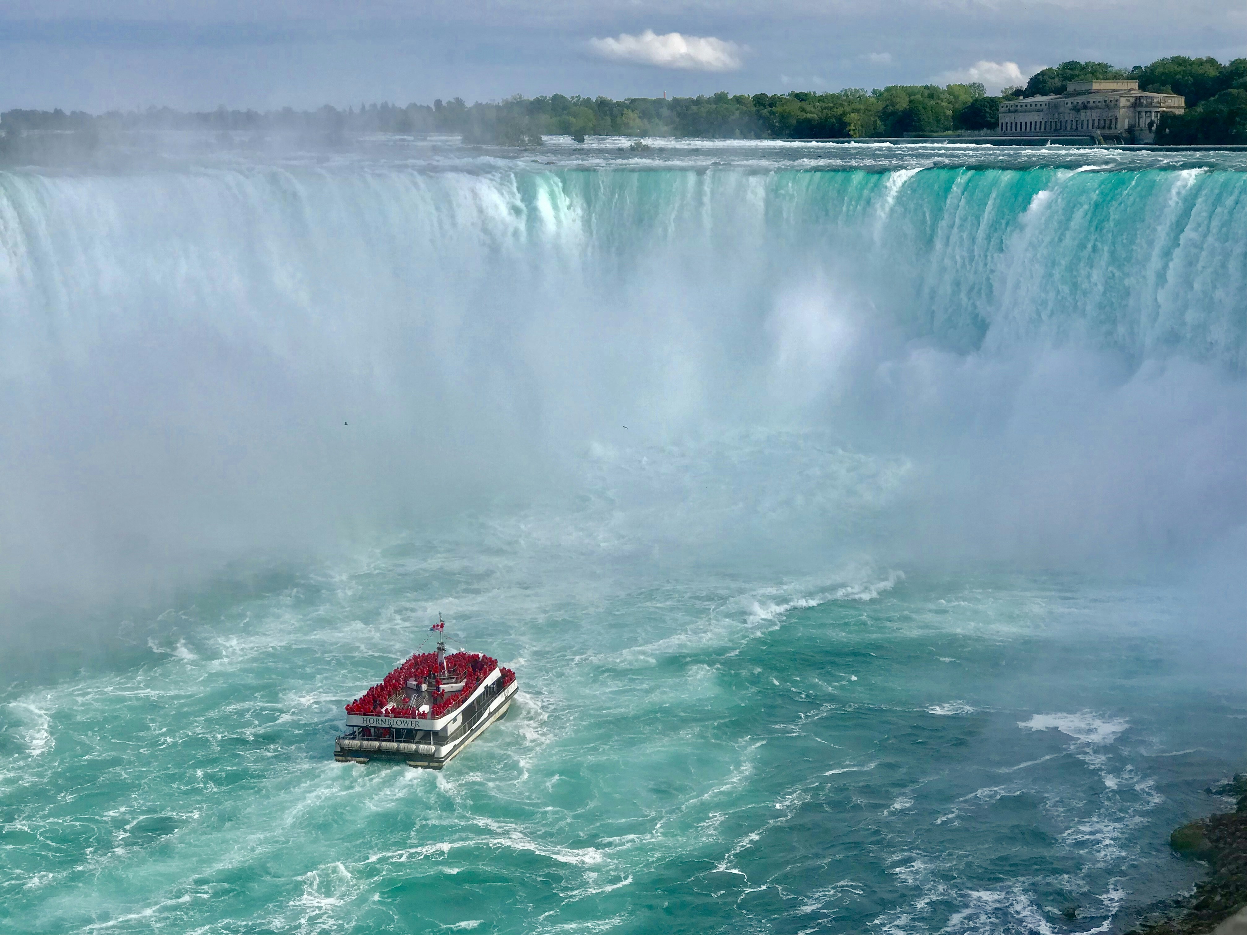 Red and white cruise ship near waterfalls photo – Free Blue Image on ...