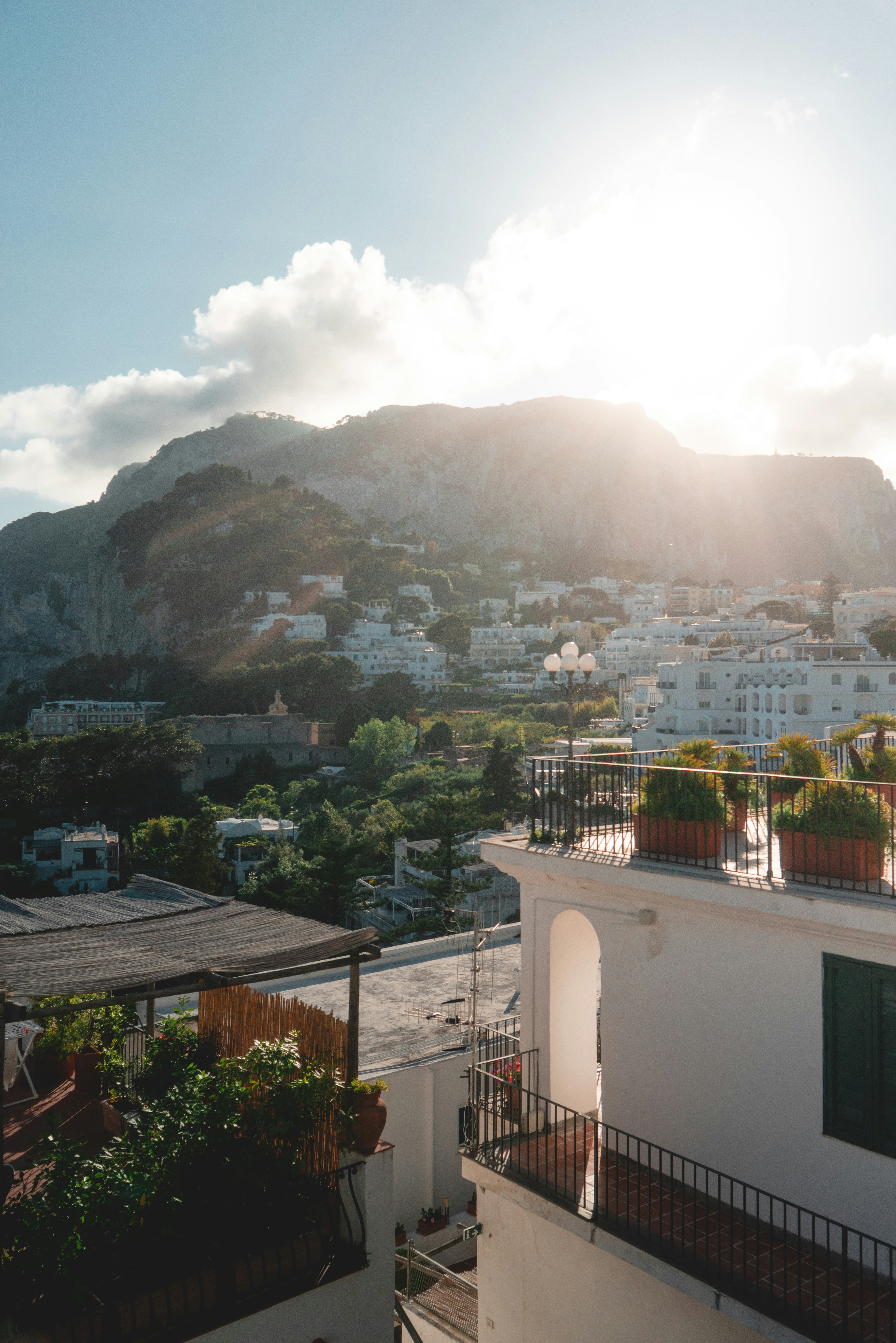 Sunlit Terrace Overlooking a Whitewashed Hillside Village at Golden Hour