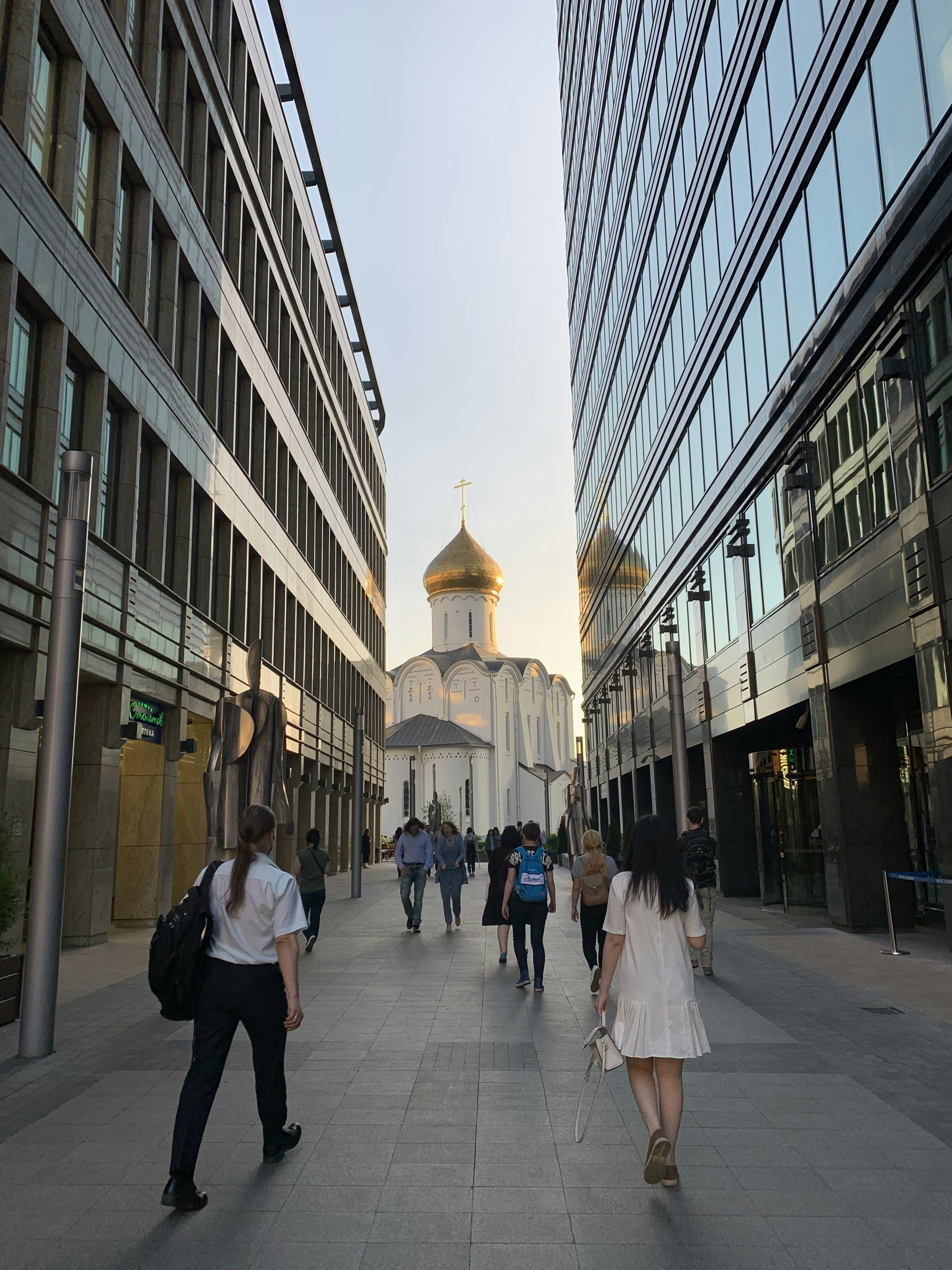 People walking between buildings photo – Free Human Image on Unsplash