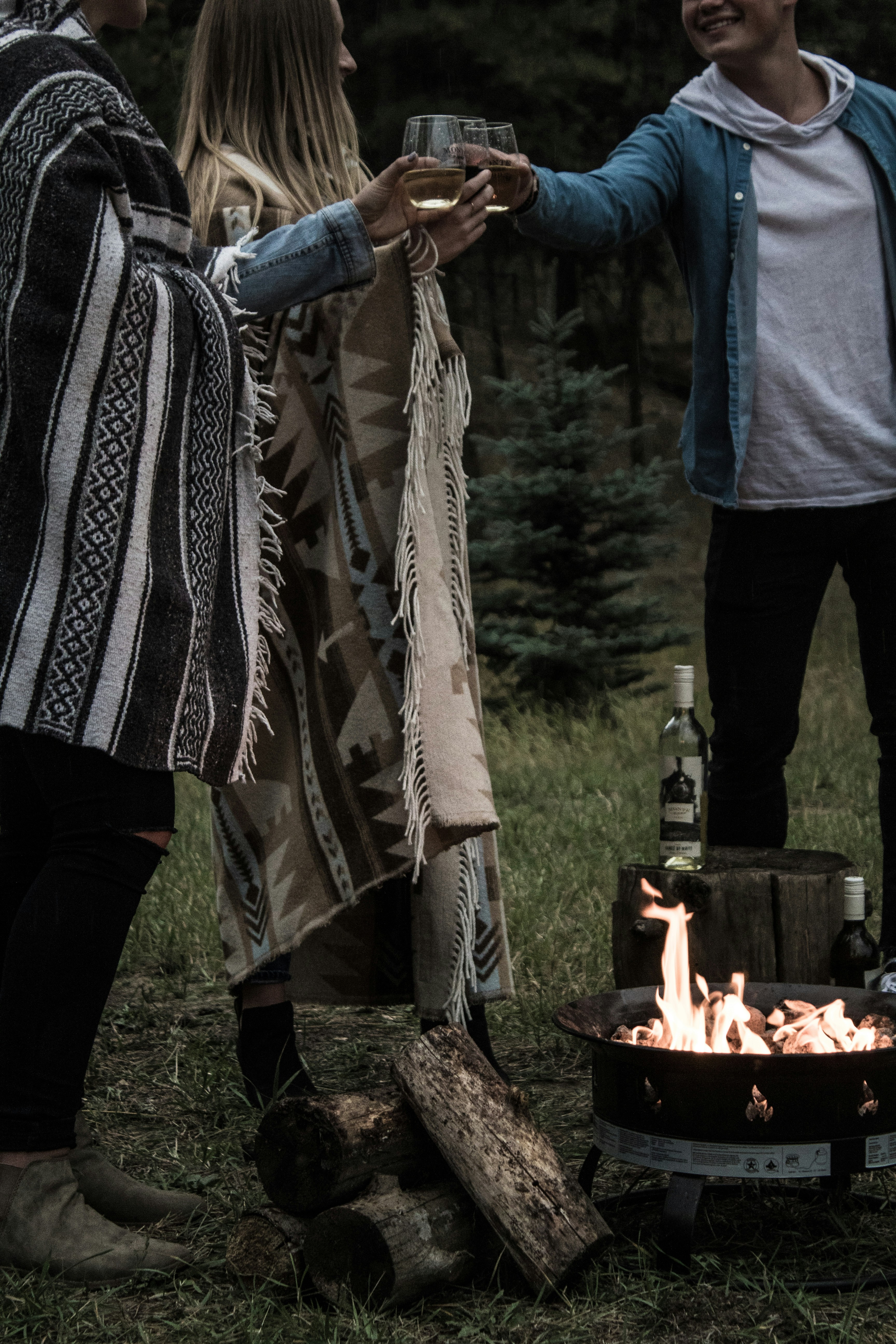 Ember Circles: Blanket-Wrapped Friends Toast by a Flickering Campfire