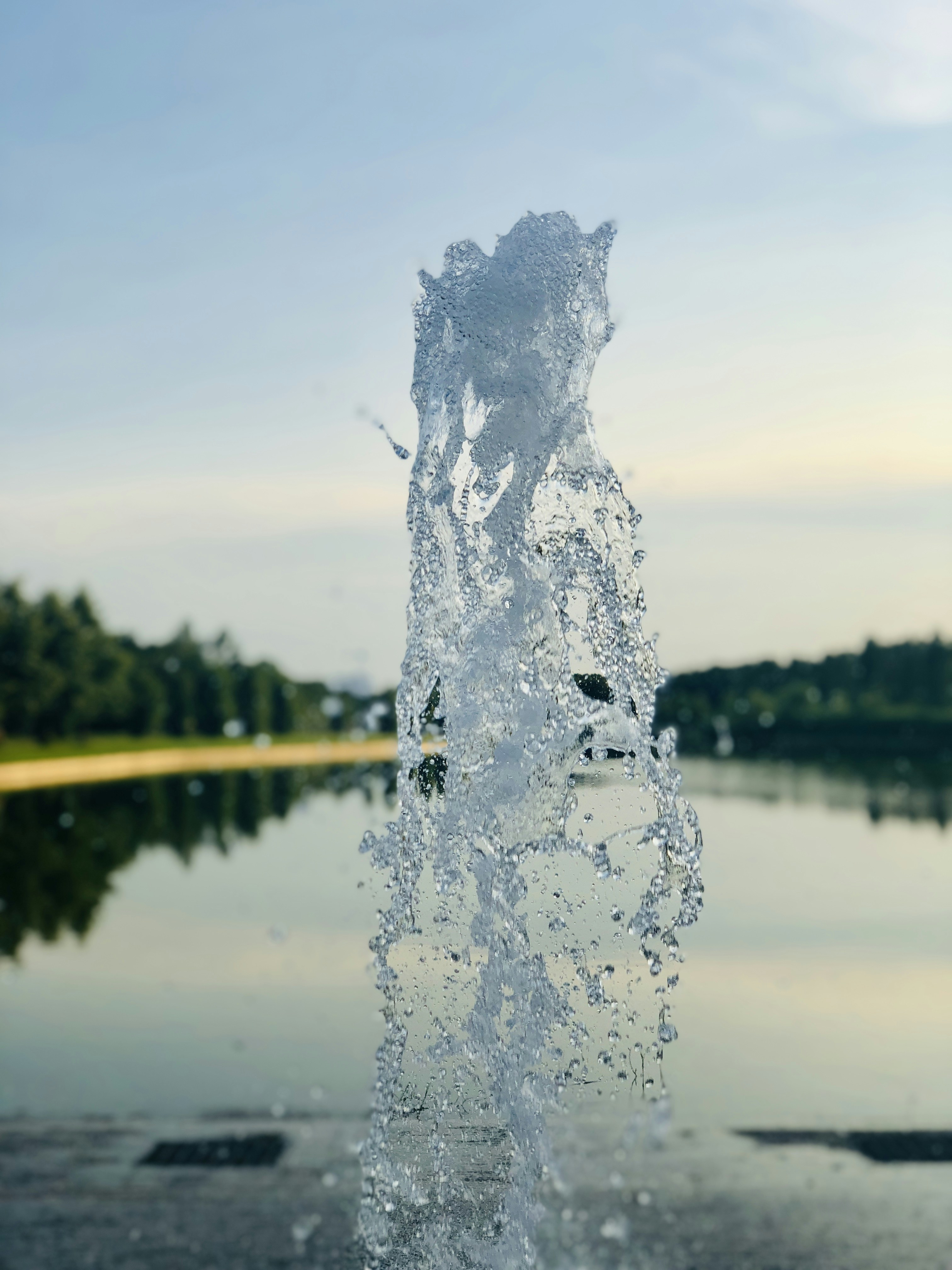 Center of Spray: A Fountain Portrait Against a Tranquil Lake