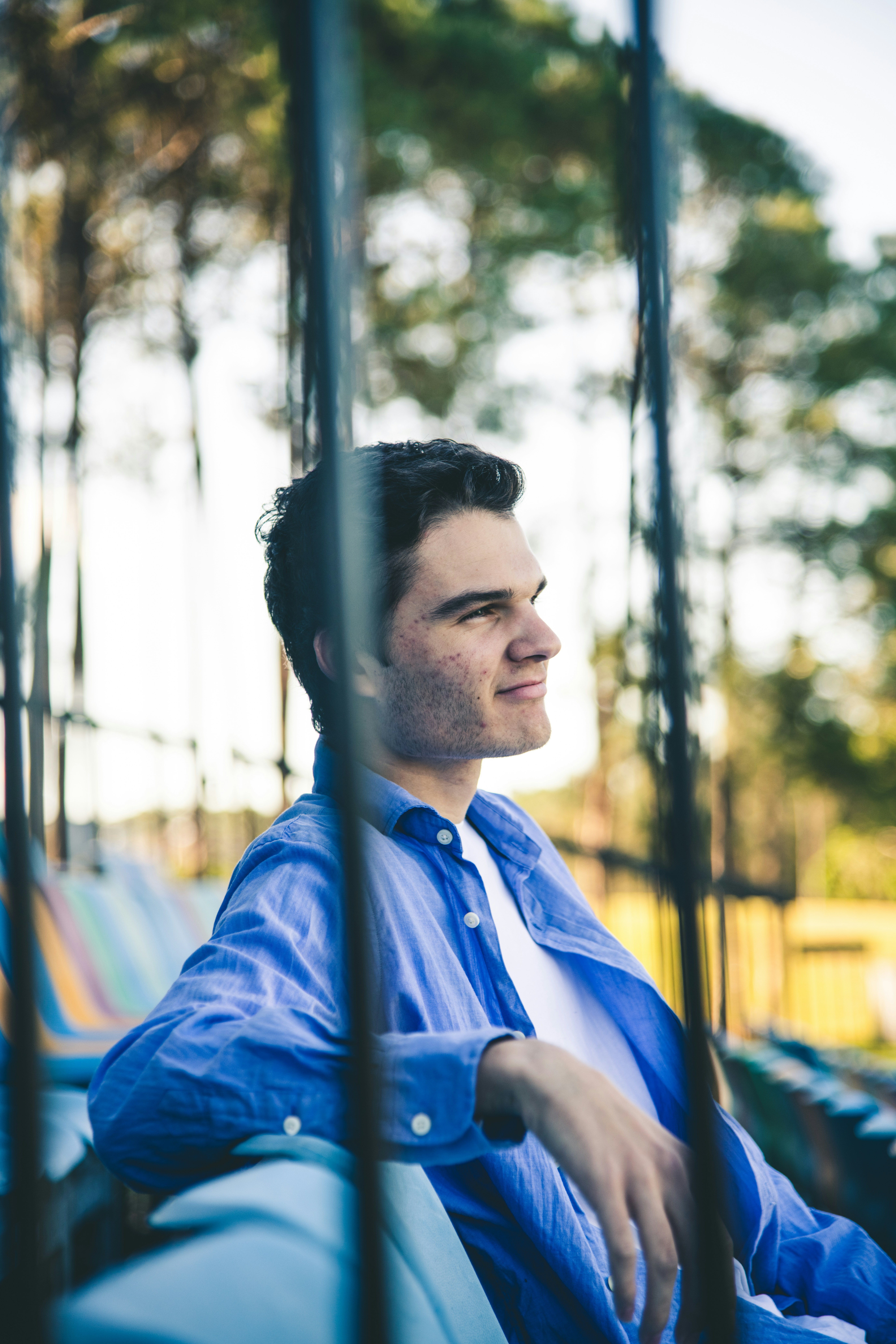 Between Rails and Sunlight: A Quiet Portrait on an Empty Bleachers