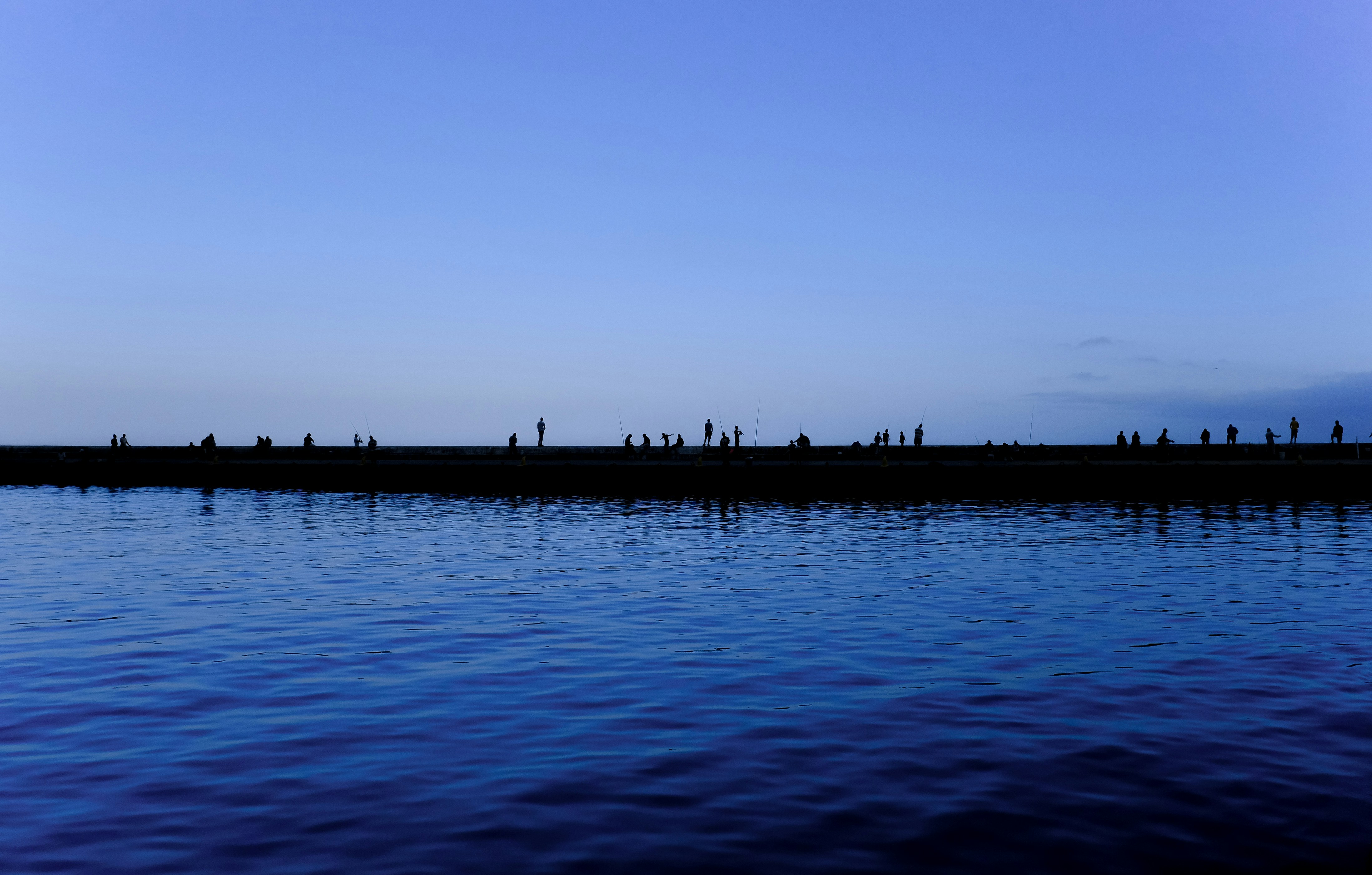 Silhouette photo of people on dock above water photo – Free Sea Image ...
