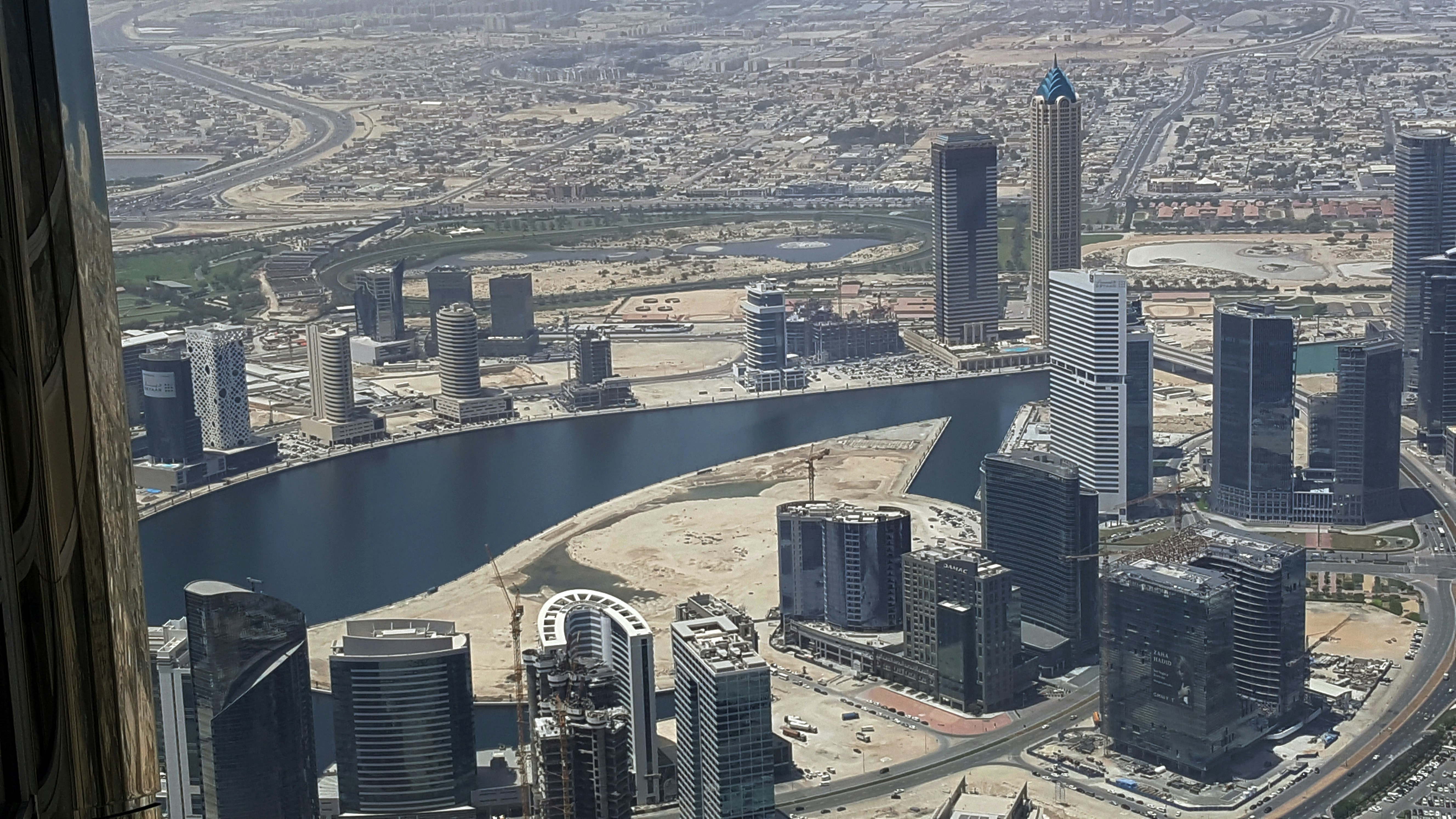 Urban Confluence: Aerial Ribbon of Water and Skyscrapers