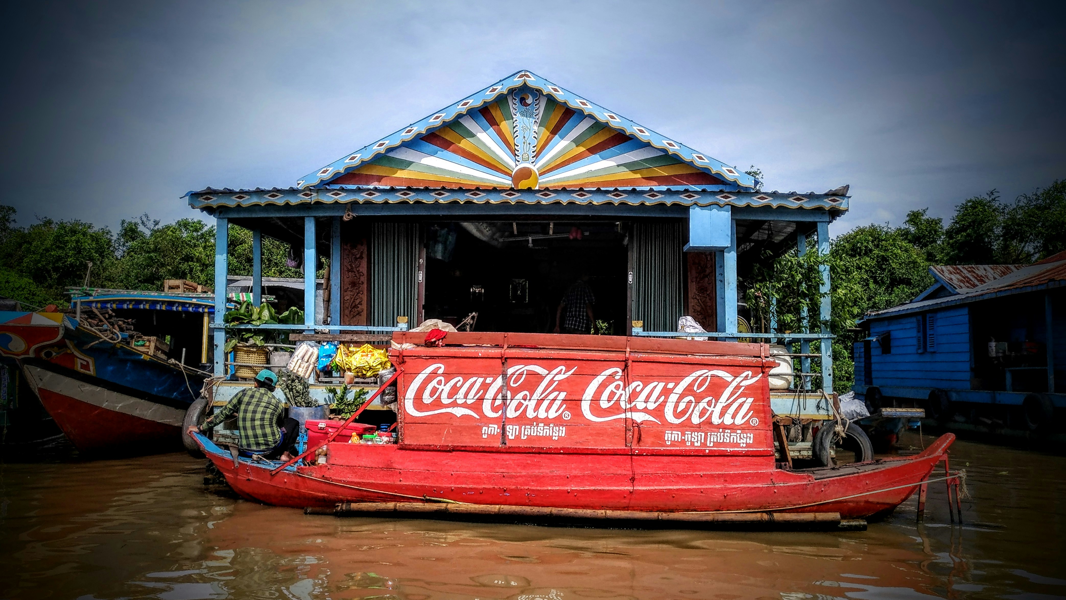 A red boat with a coca cola advertisement on it photo – Free Human ...