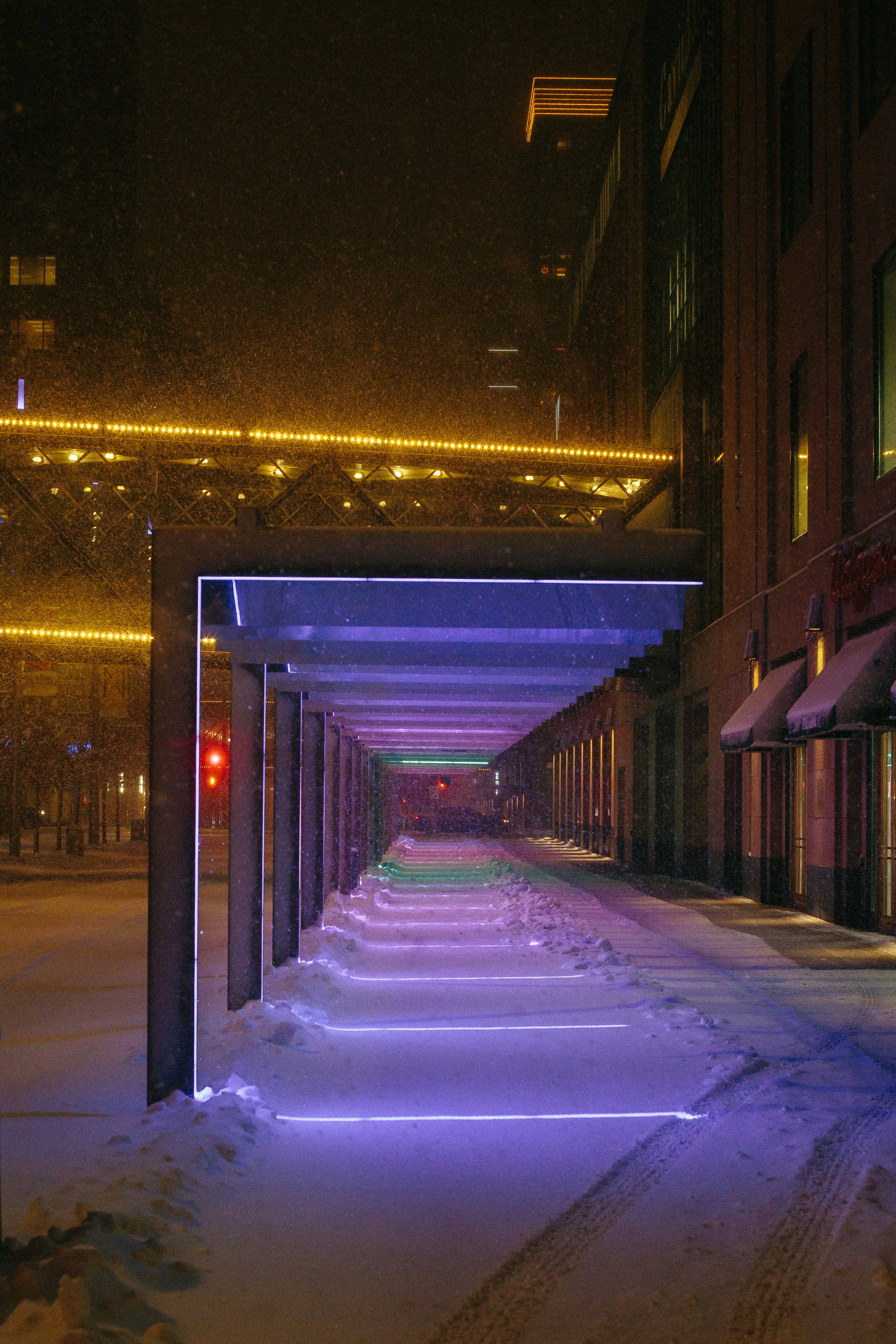 a long row of buildings on a snowy street