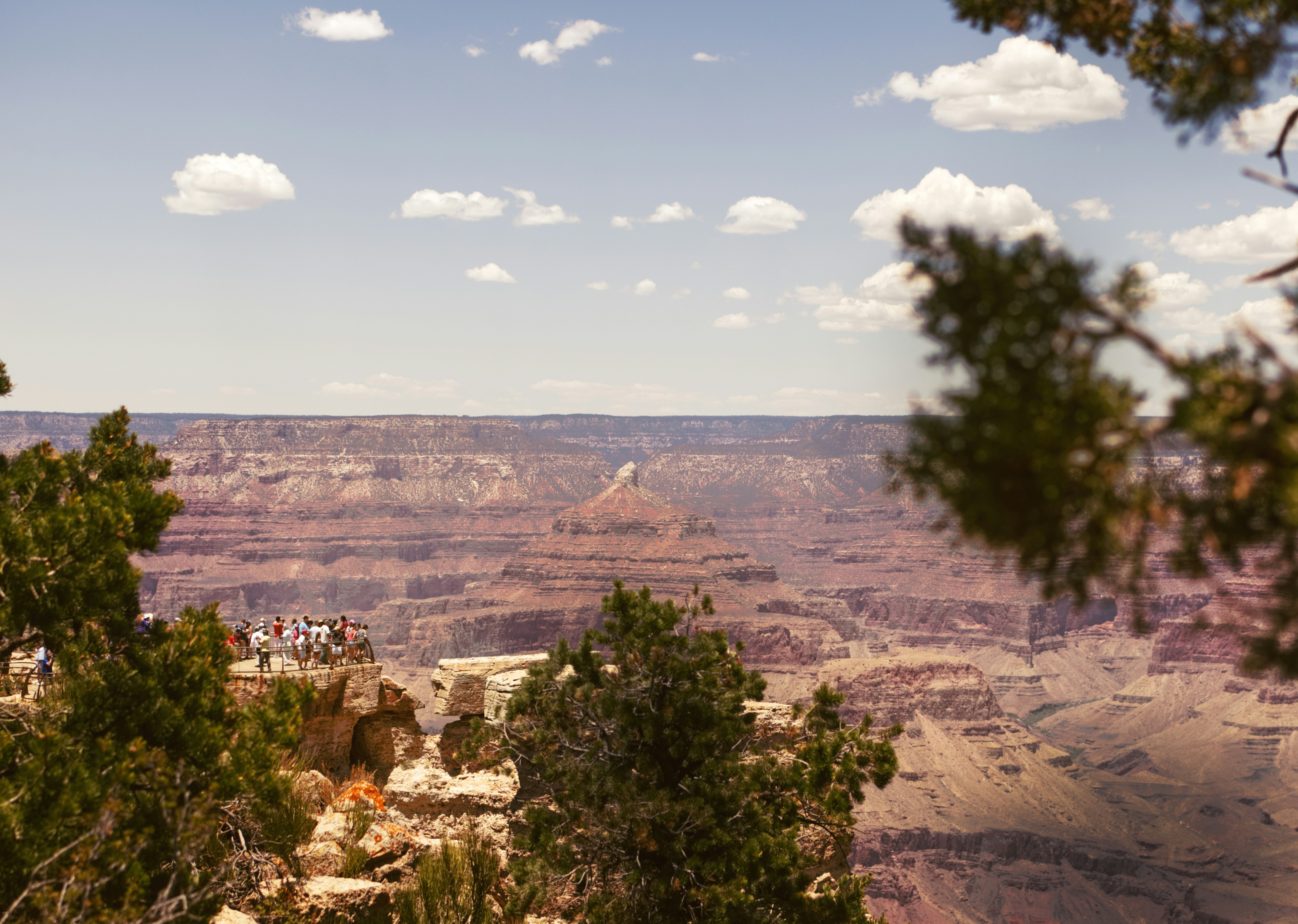 Rimside Echoes: Tourists at a Grand Canyon Vista in Golden Hour Light