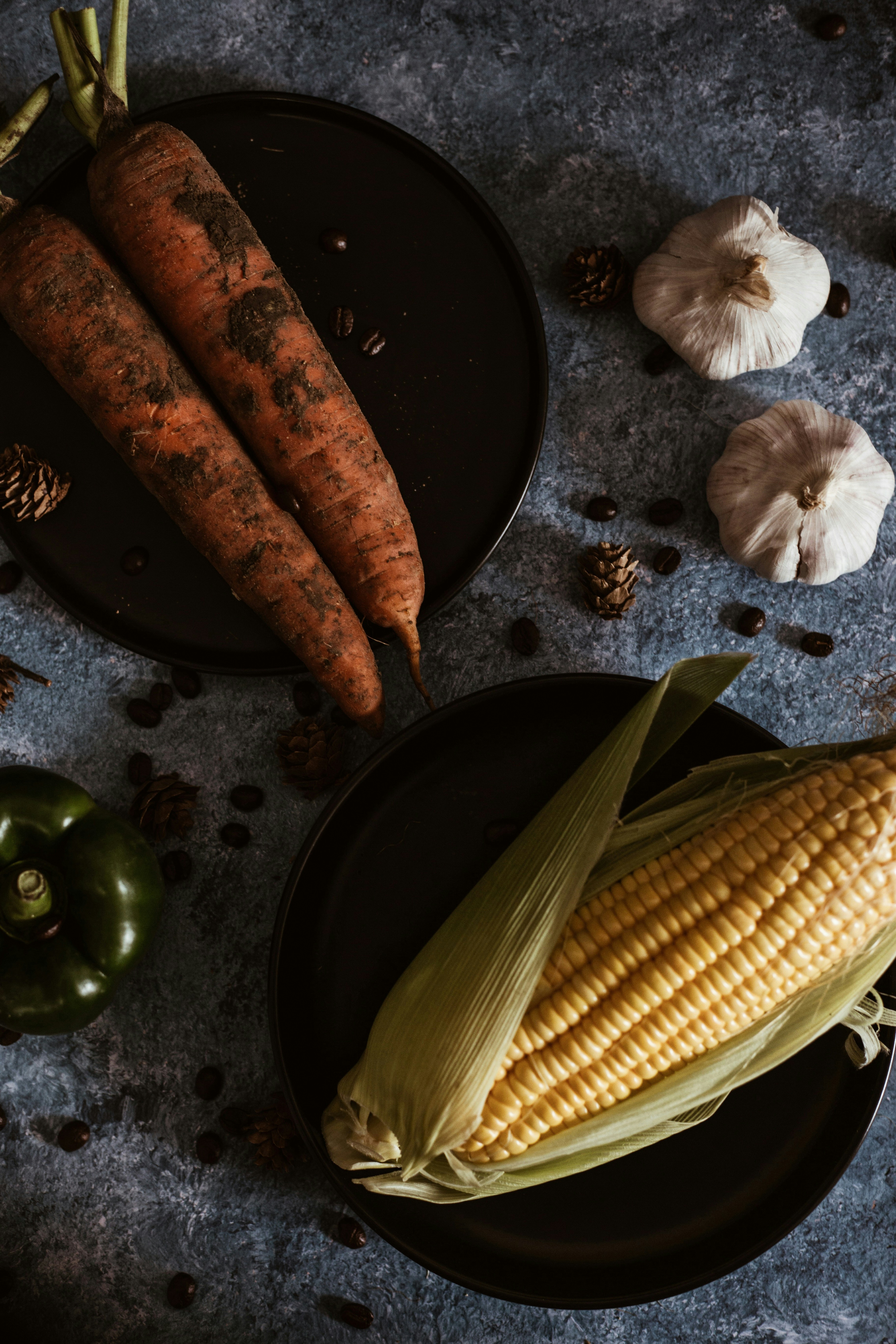 Harvest in Half-Light: Corn and Carrots on a Dark Slate