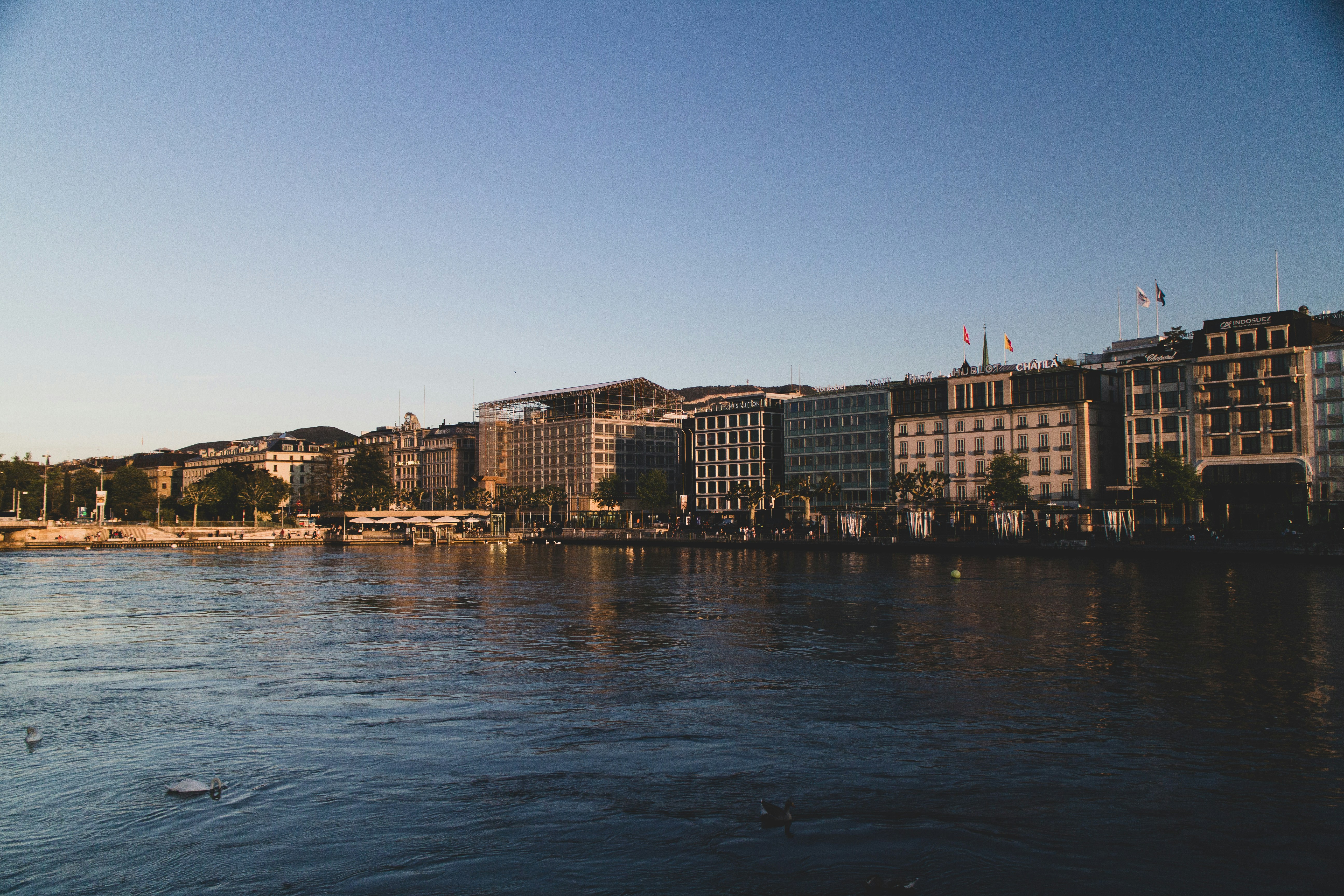 Beige concrete buildings near body of water photo – Free Switzerland Image on Unsplash