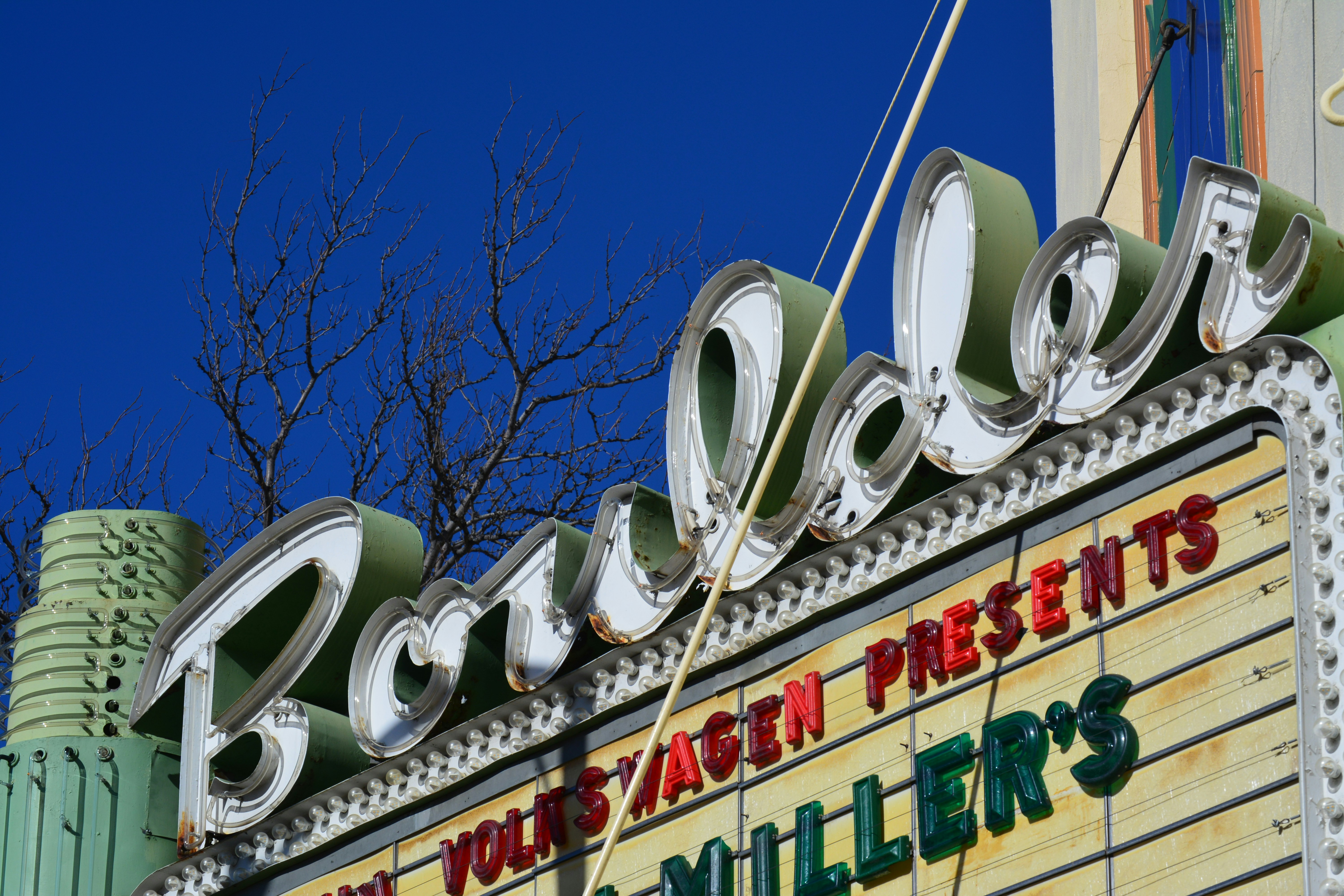 Retro Theater Marquee Glowing Under a Clear Blue Sky