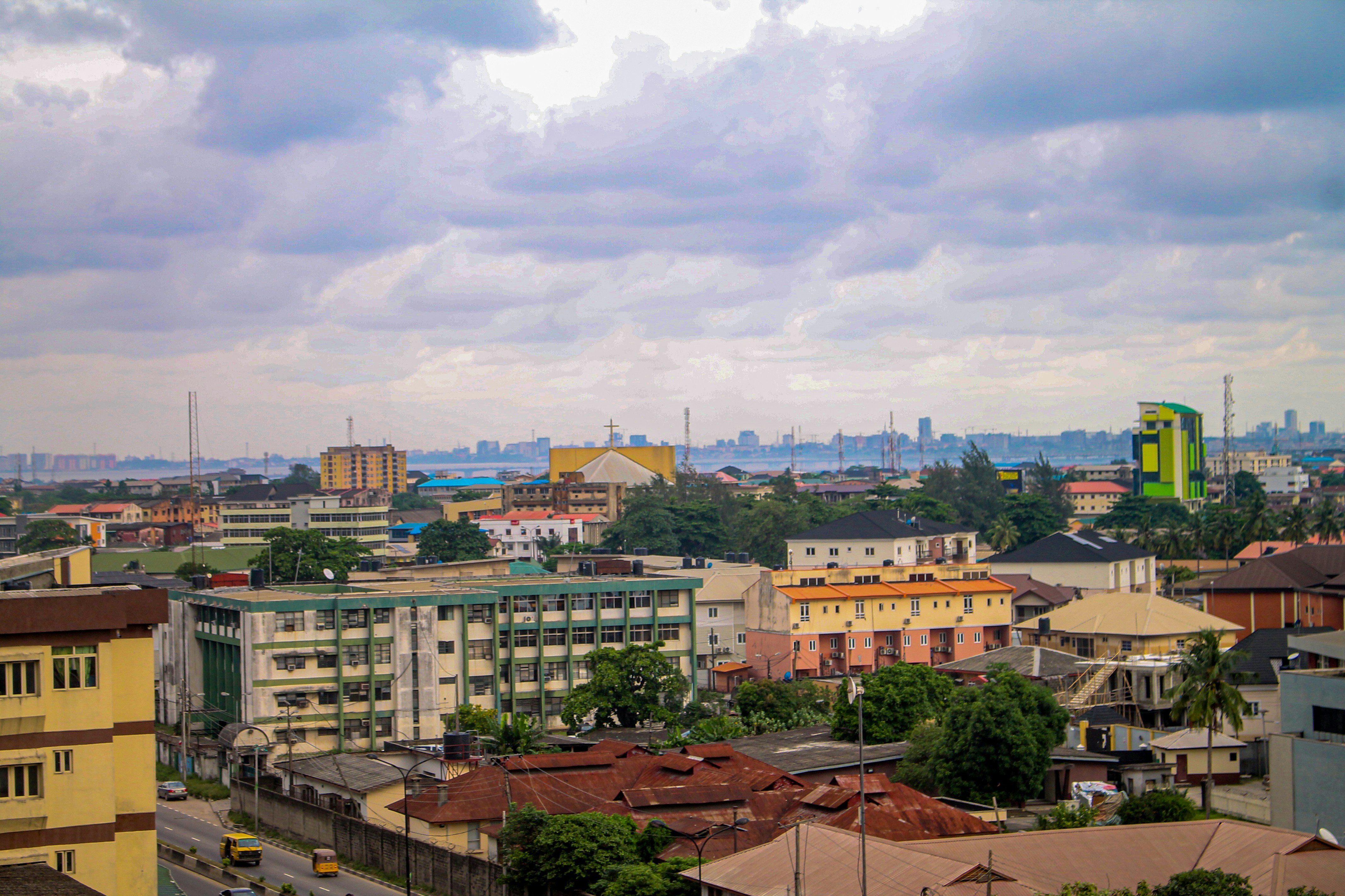 Cityscape with diverse architecture and cloudy sky backdrop.