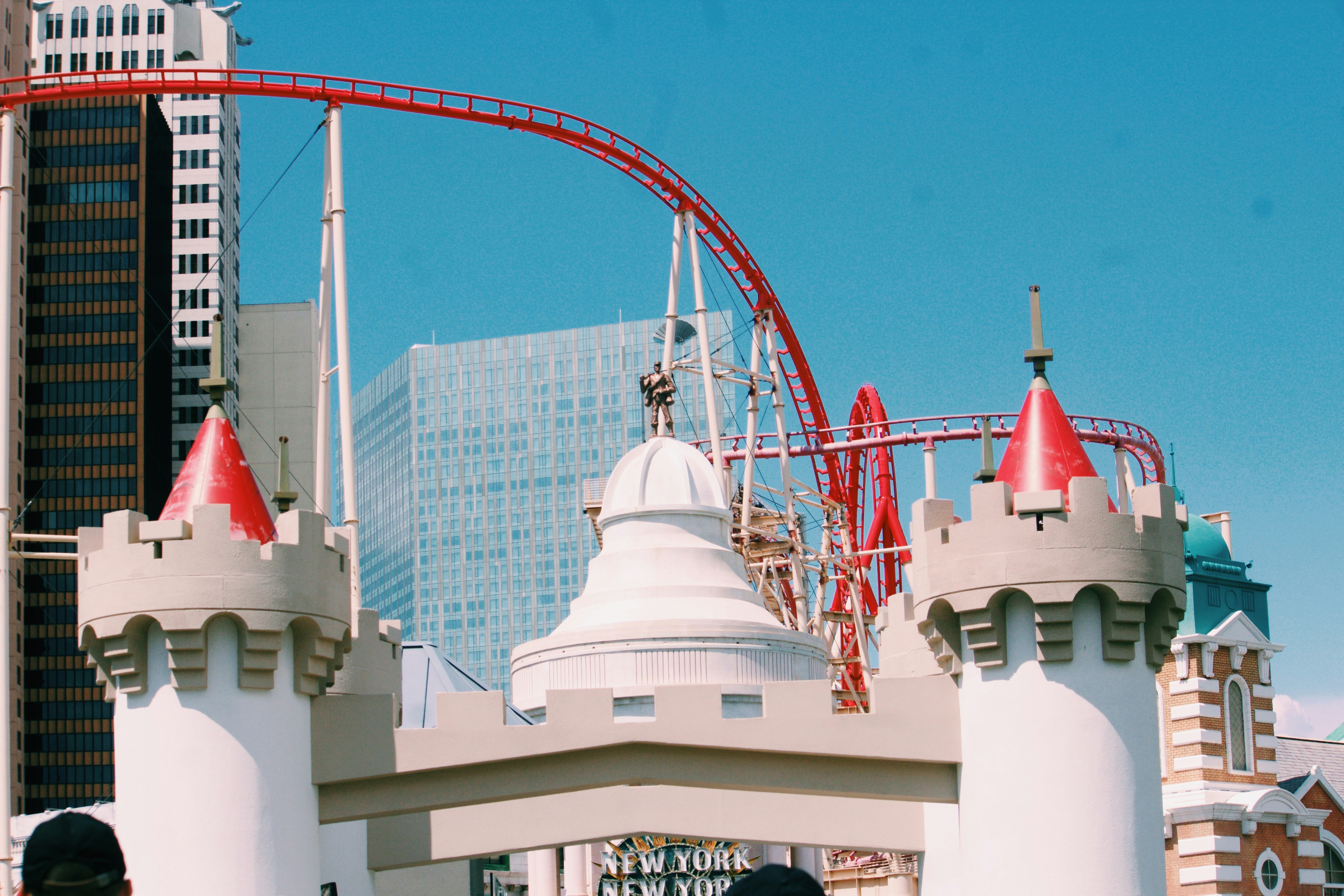 Ivory Castle Turrets Framed by a Crimson Roller Coaster Loop