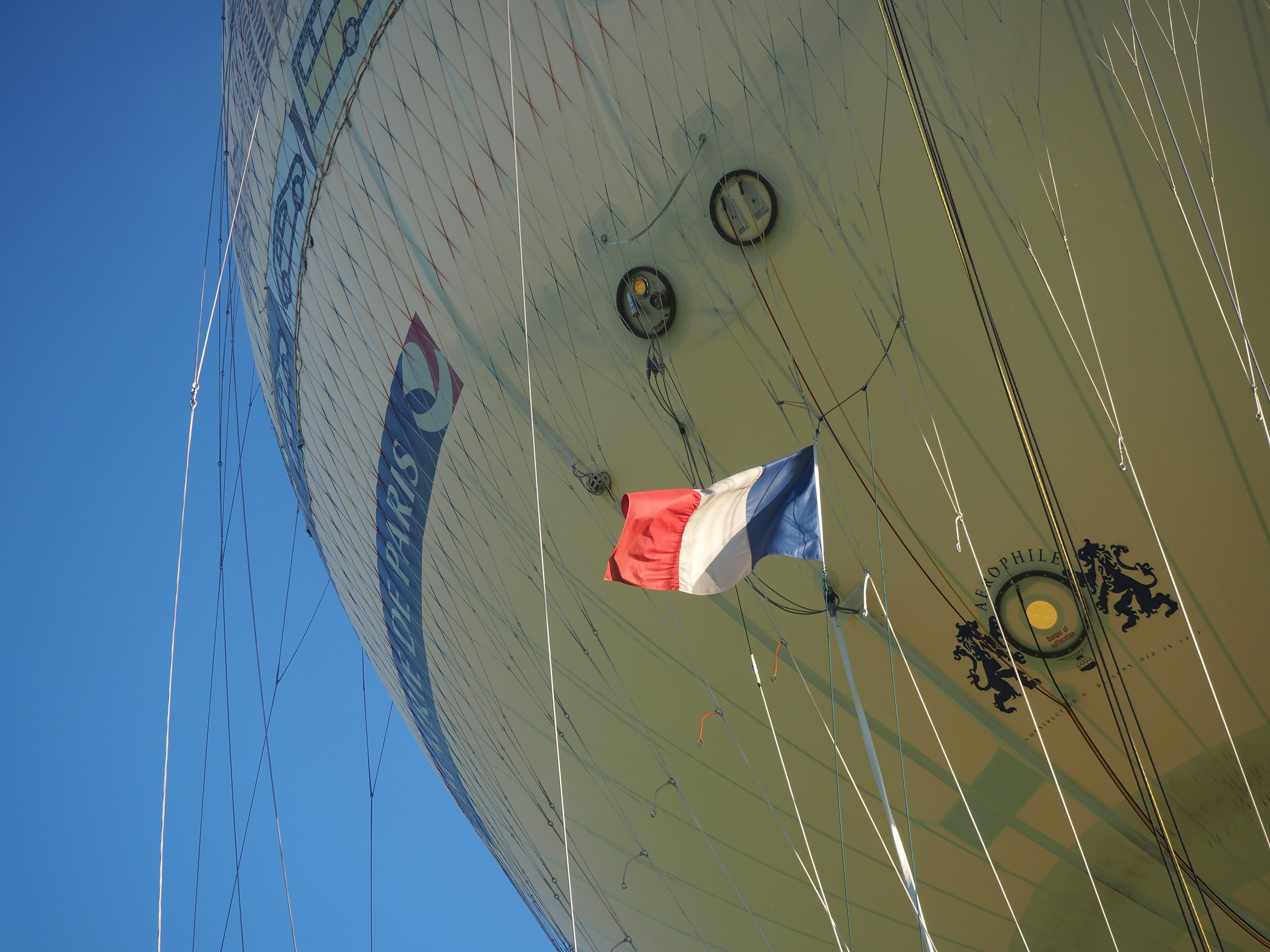 Tricolor at the Lift: A French Flag Adorns a Tethered Balloon