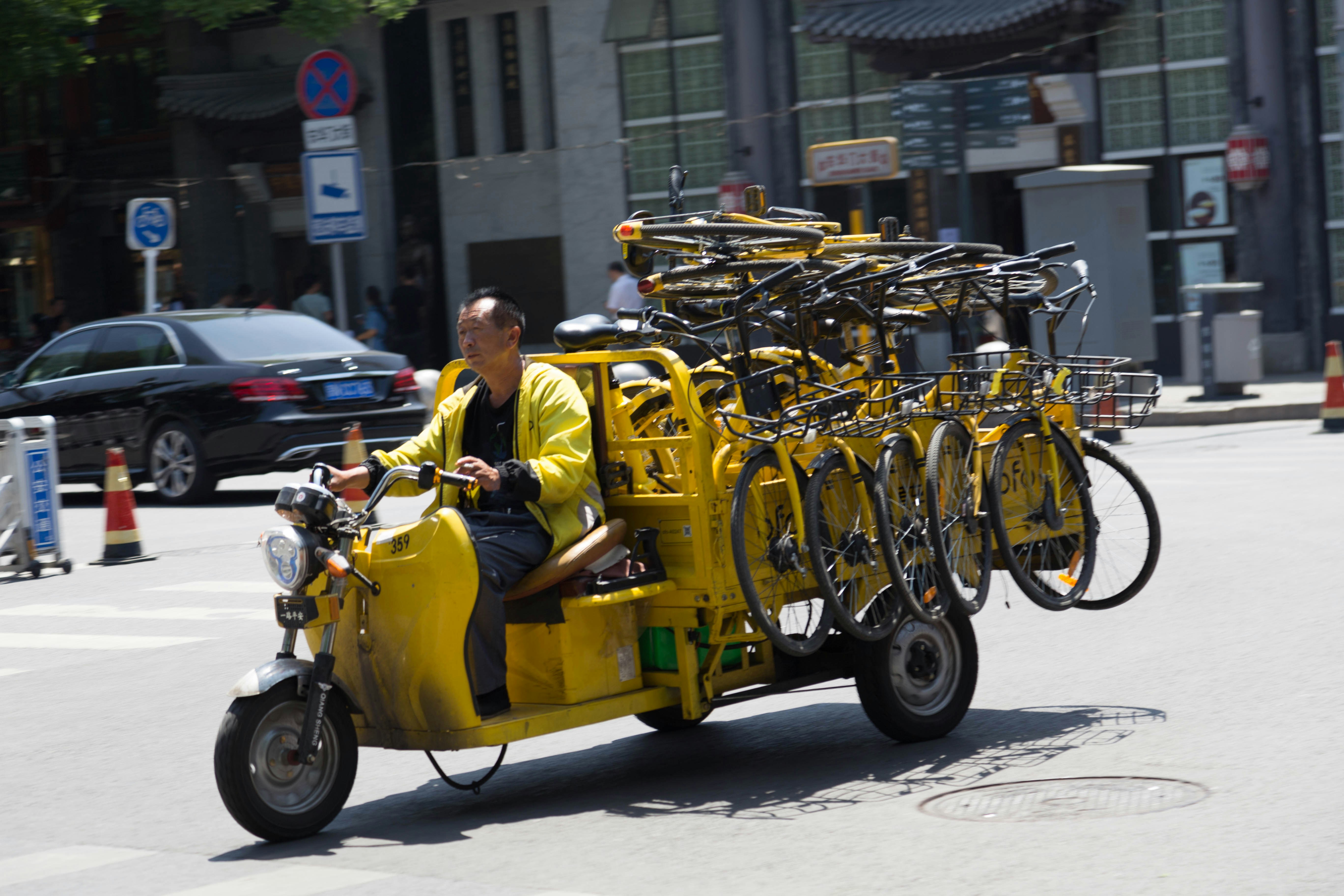 Yellow City Carrier: One-Man Trike Hauls Bicycles Through Busy Streets