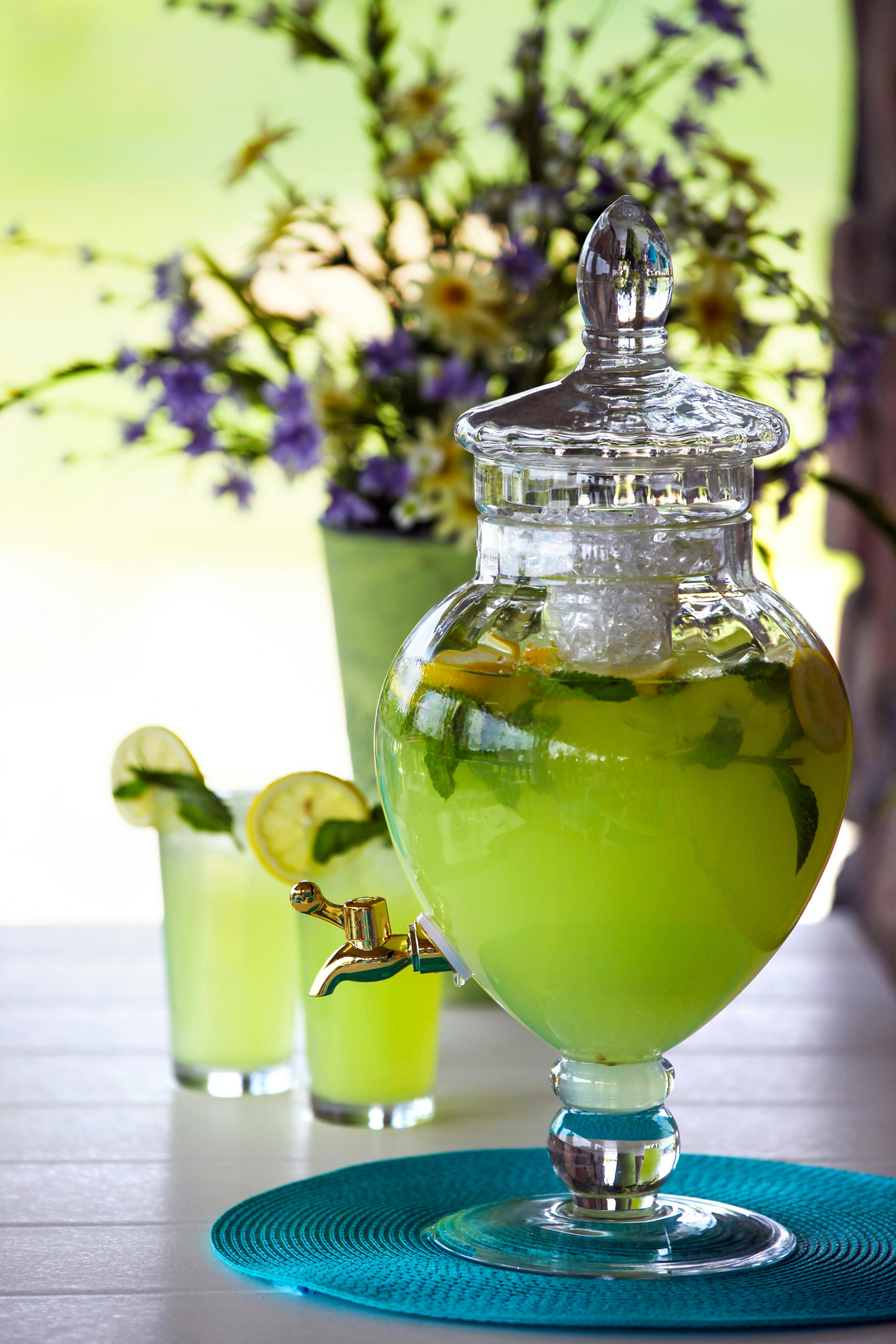 Verdant Glow: Limeade in a Crystal Tap Jar on a Sunlit Table