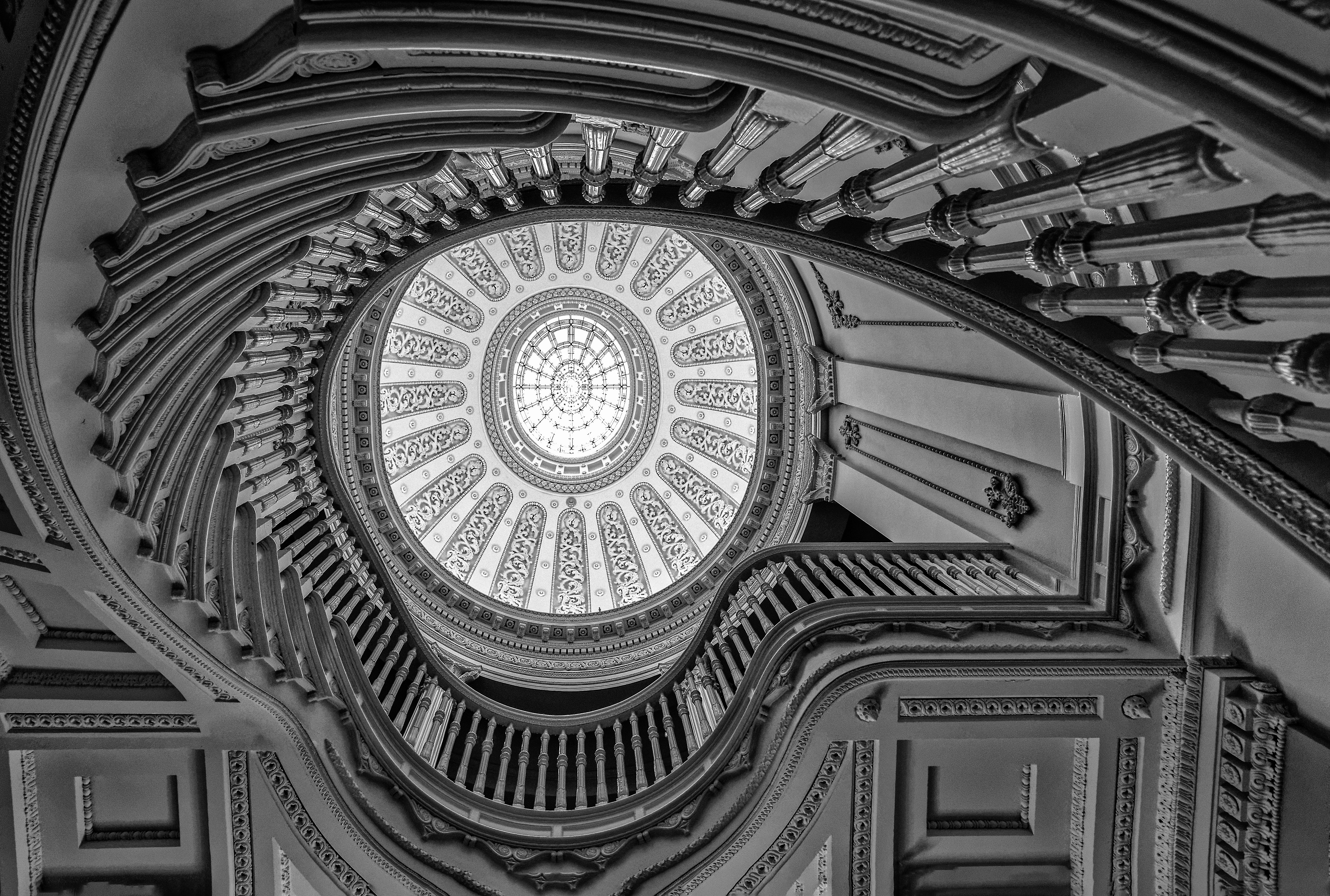 a spiral staircase in a building with a circular window