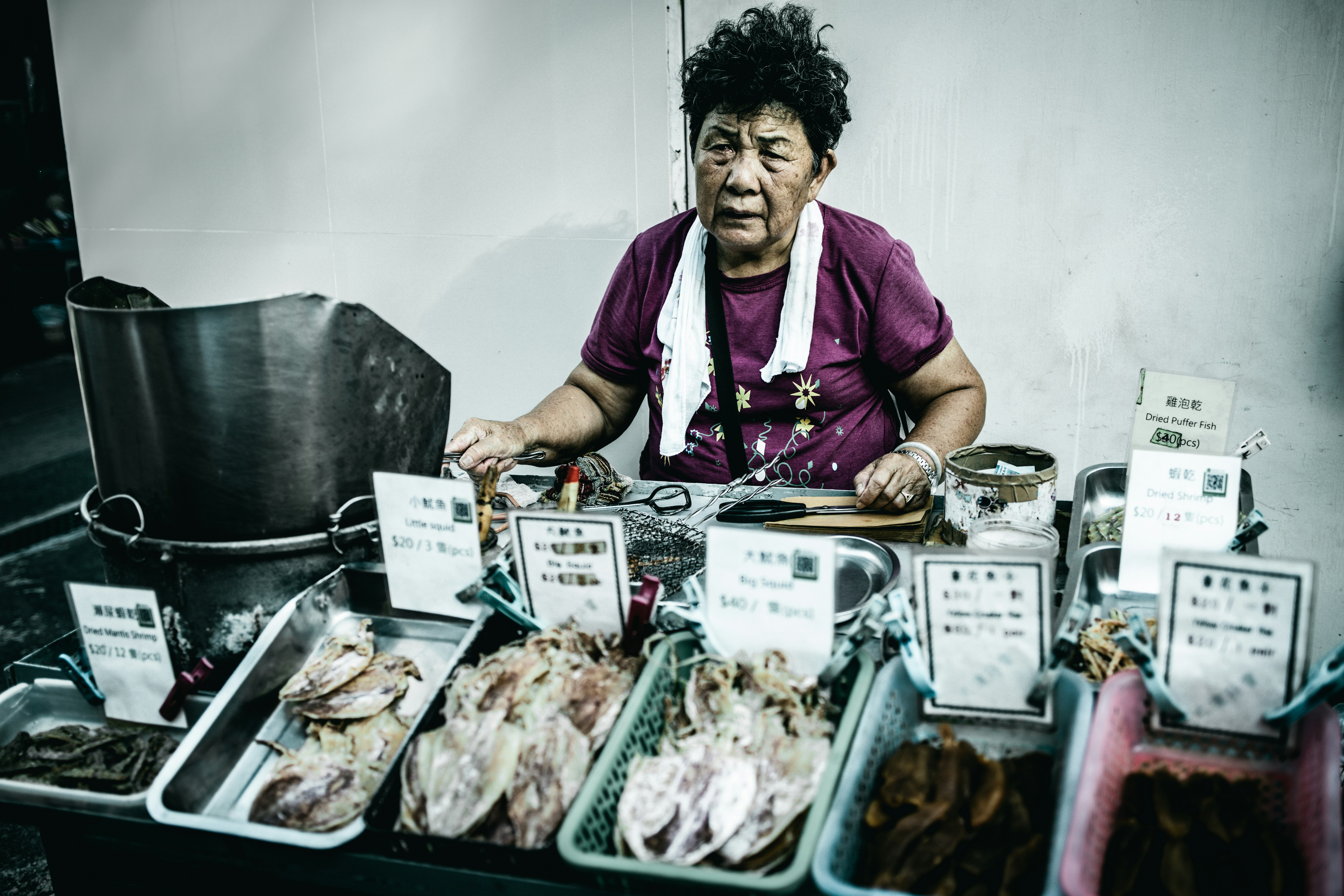 Market Vendor in a Seafood Stall Under Soft Lighting
