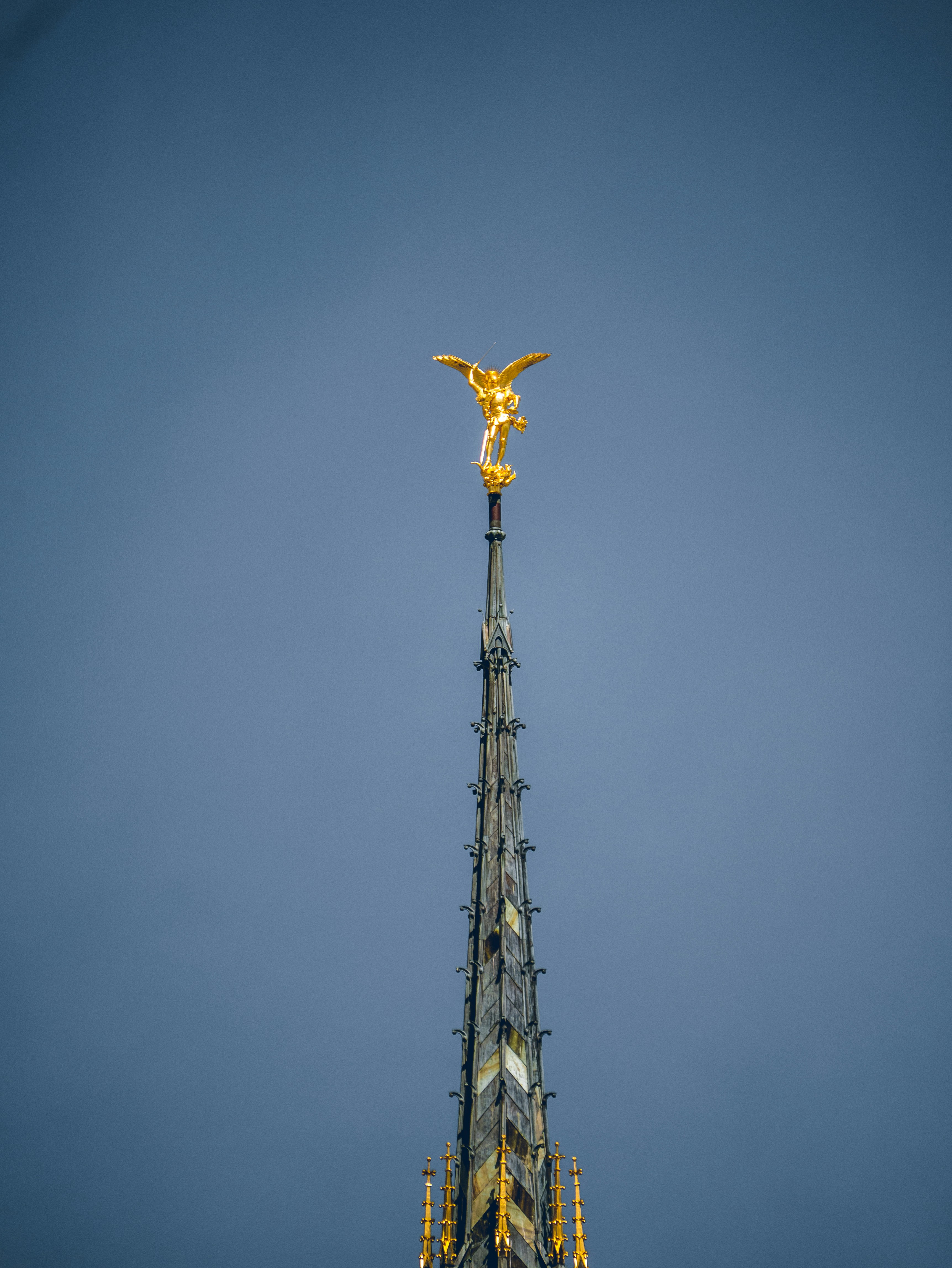 Gilded Apex: The Angel at the Summit of a Gothic Spire