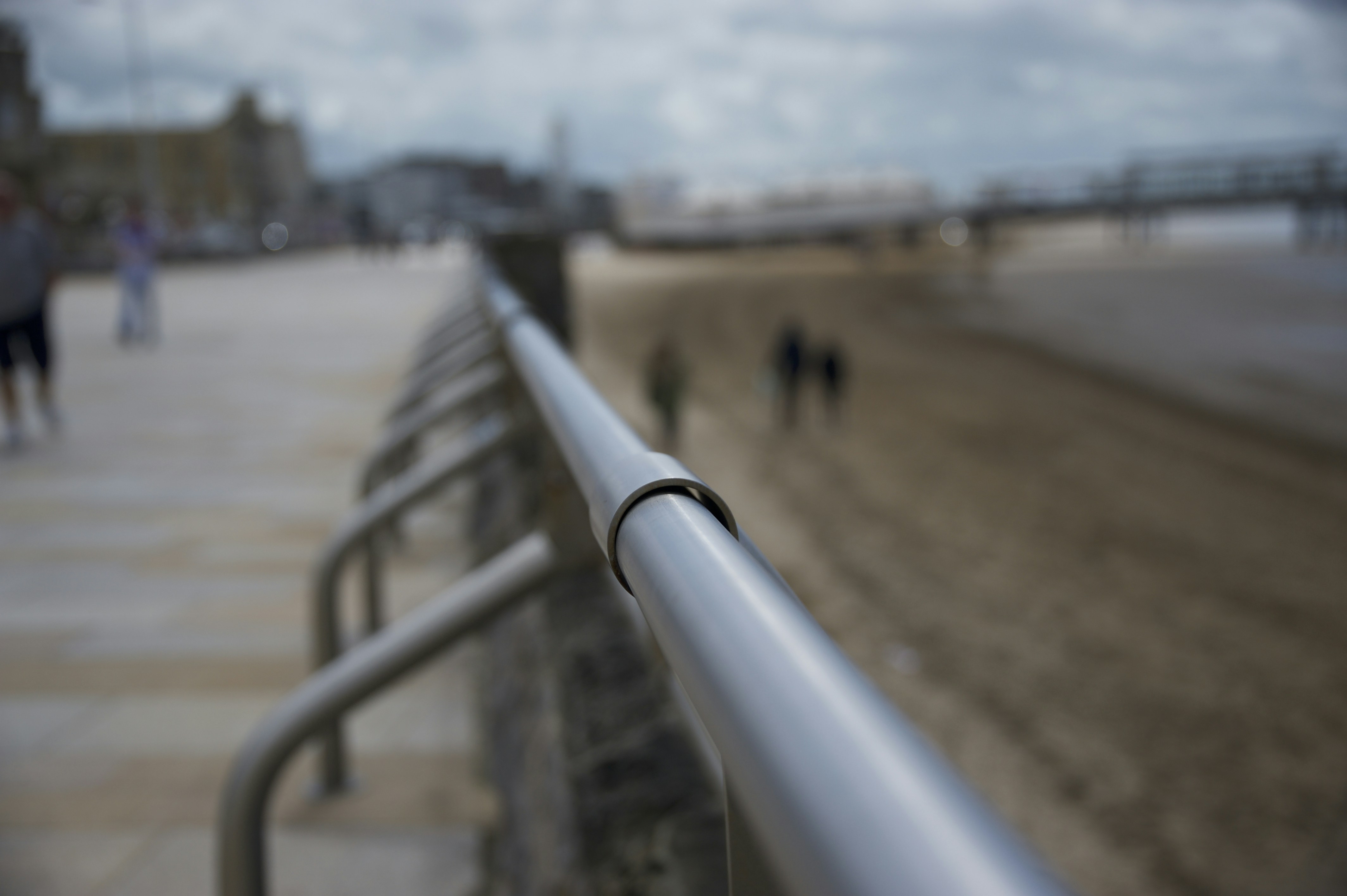 Rail to the Quiet Sea: A Close-Up of a Promenade Railing