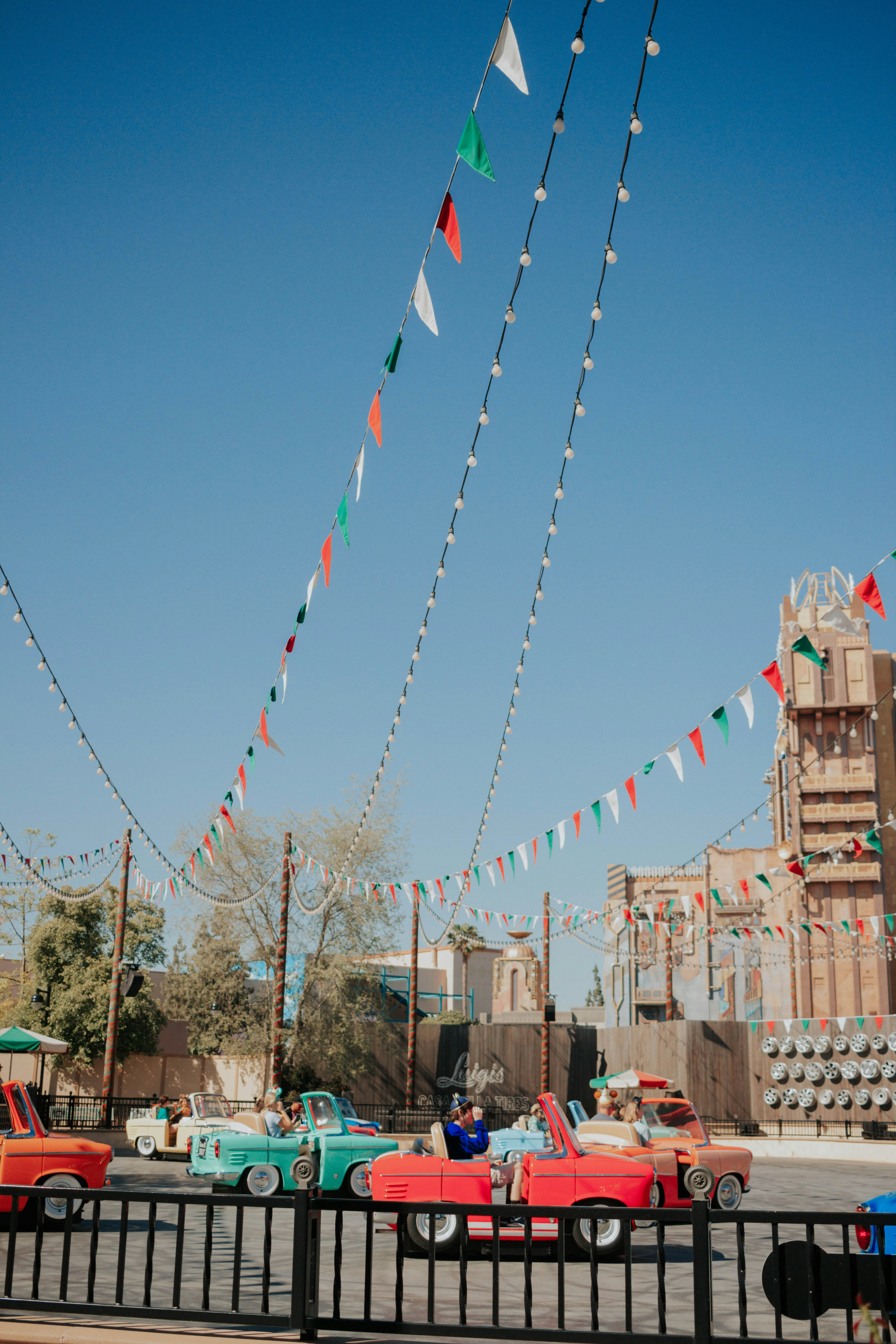 Vintage Convertible Parade Beneath a Sky of Flags