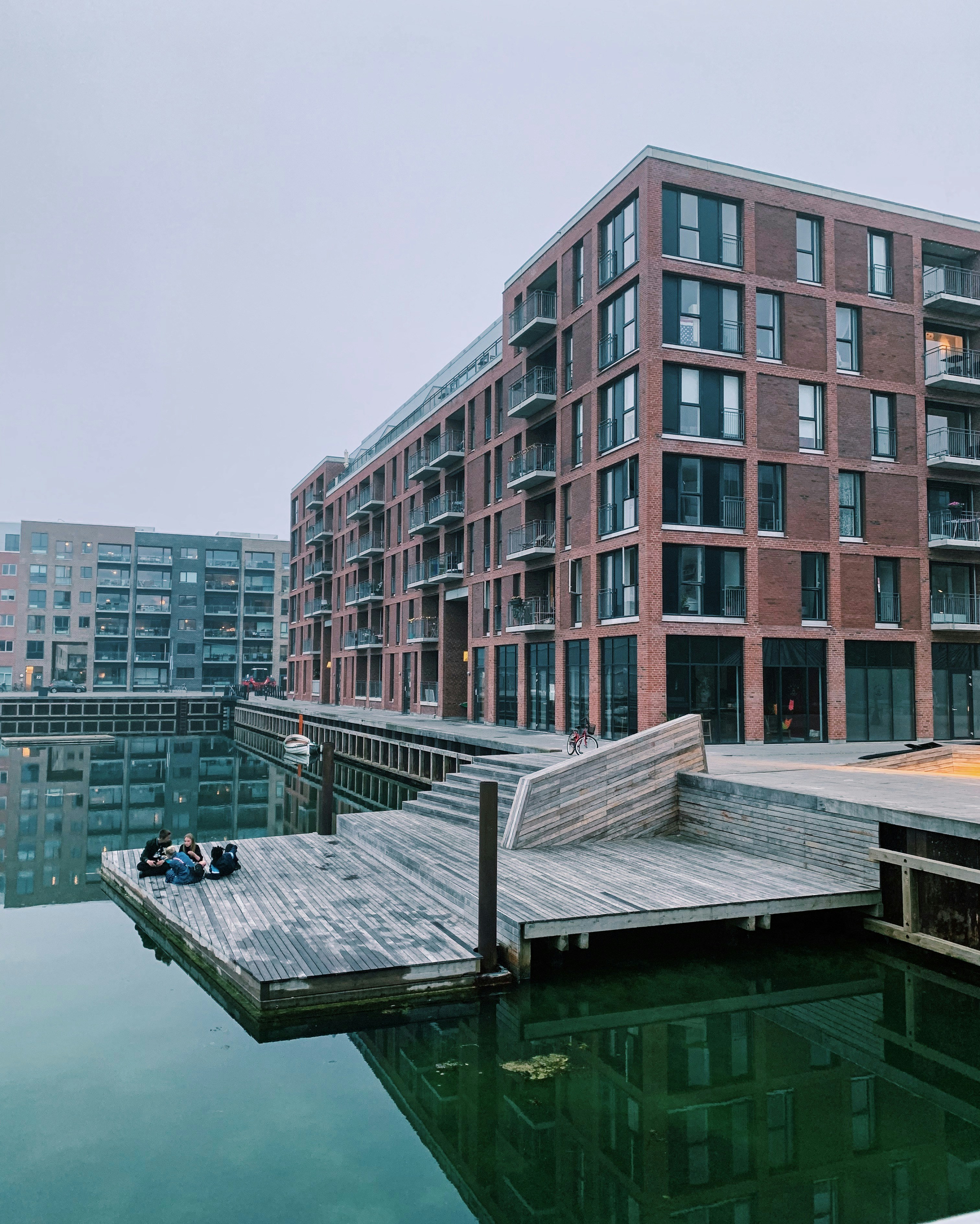 Brick Arcade by the Water: Urban Docks and Reflections