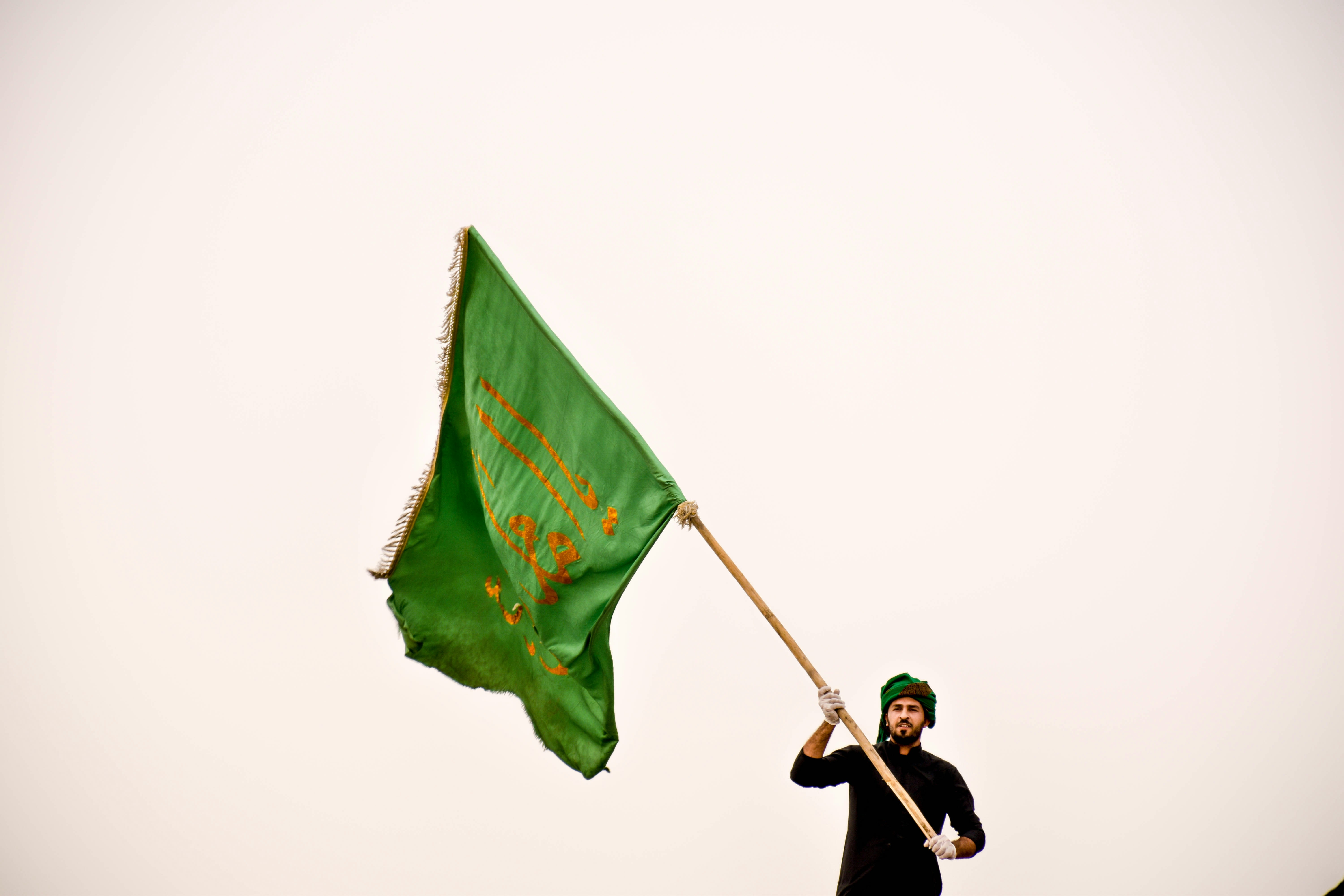 Man standing while holding green flag photo – Free Green Image on Unsplash