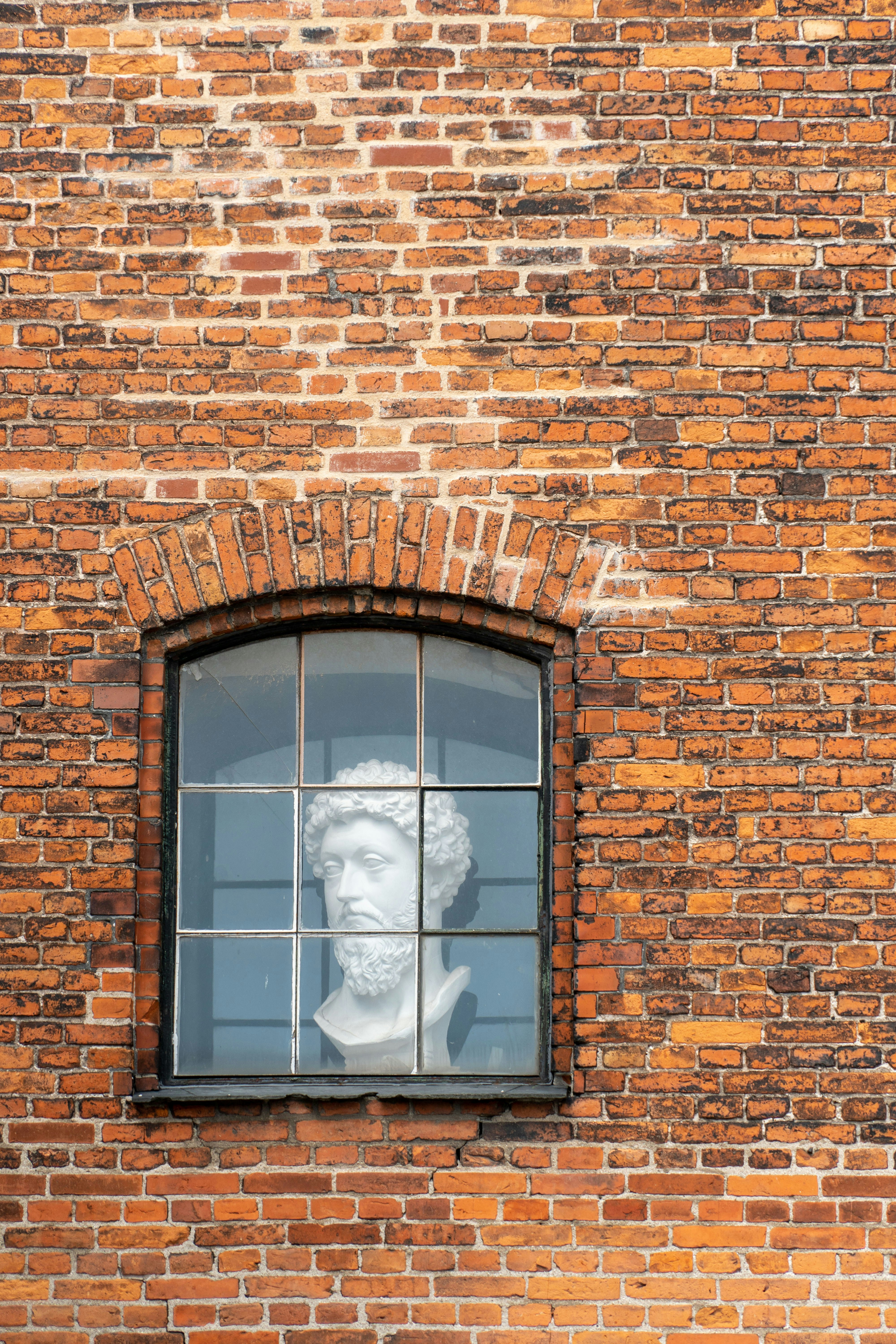 man headbust in closed window