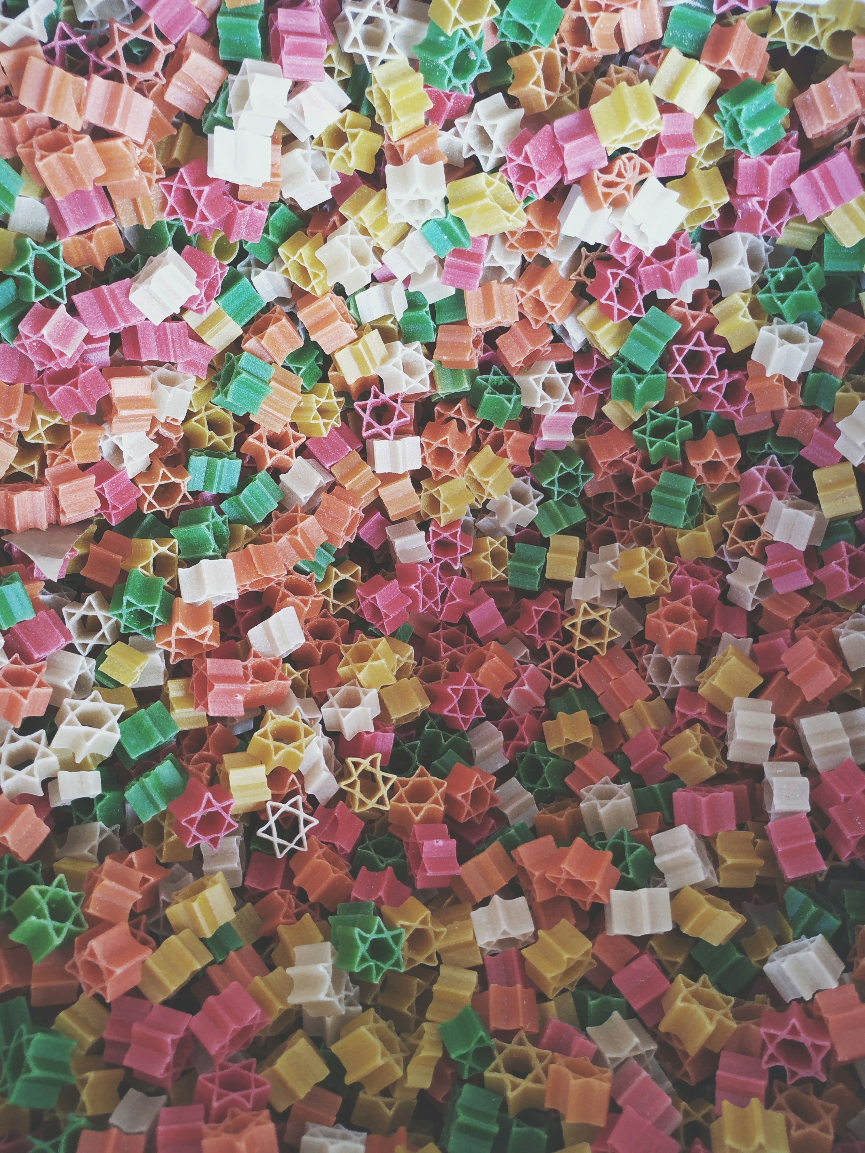 Colorful plastic interlocking blocks scattered in a random pattern.