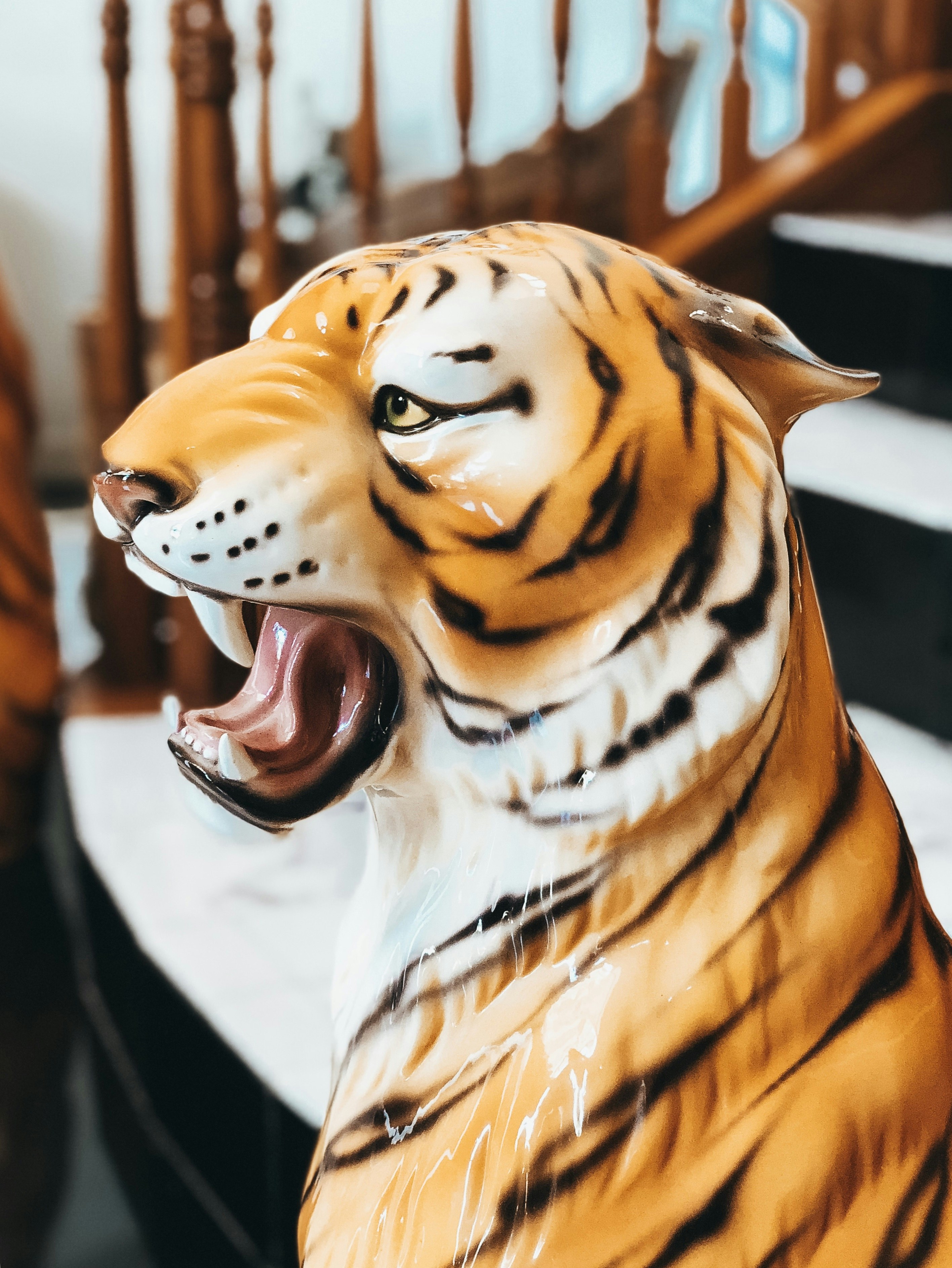 Roaring Ceramic Tiger: A glossy pop of color in a staircase vignette