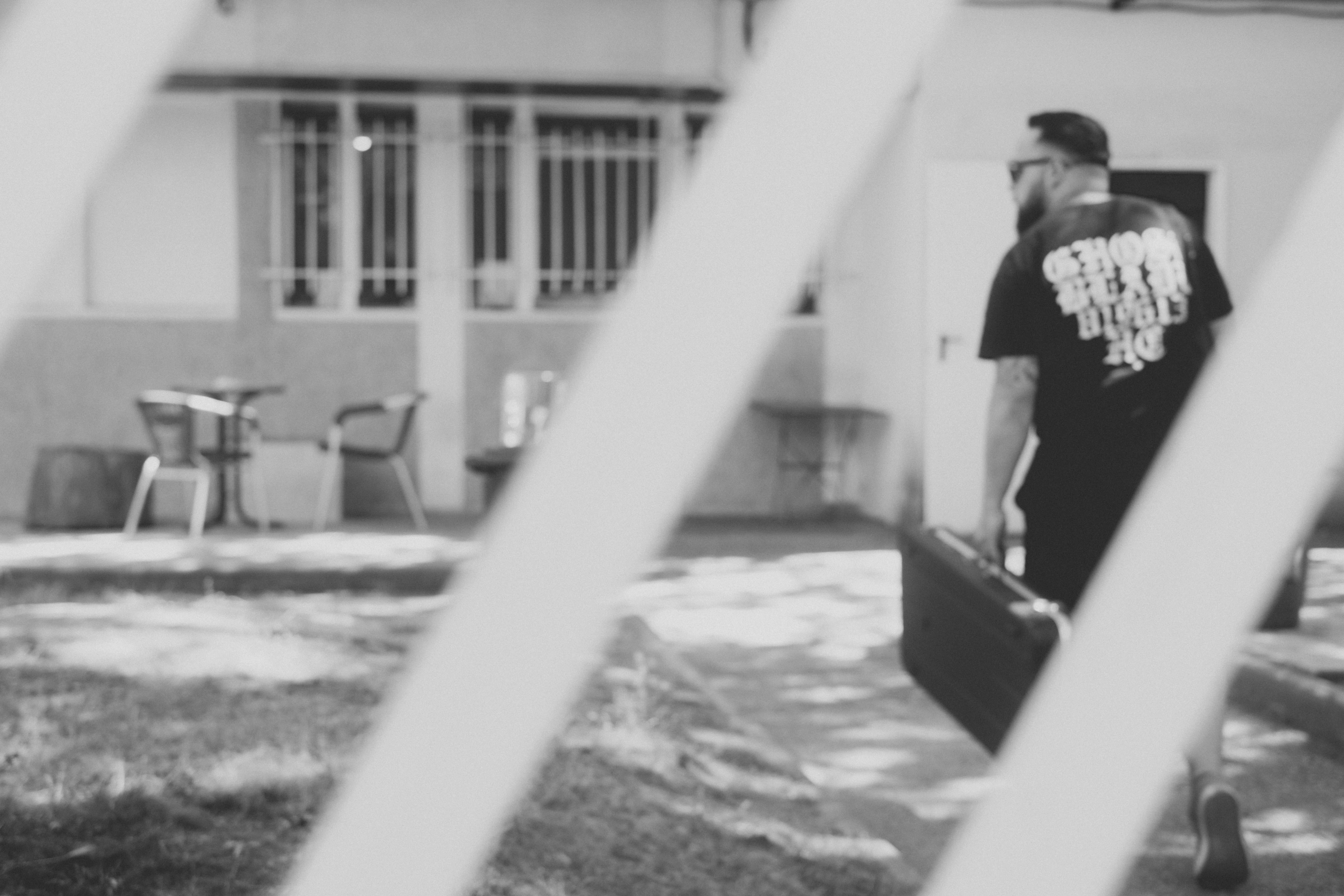 Grayscale photography of man carrying case photo – Free Grey Image on ...