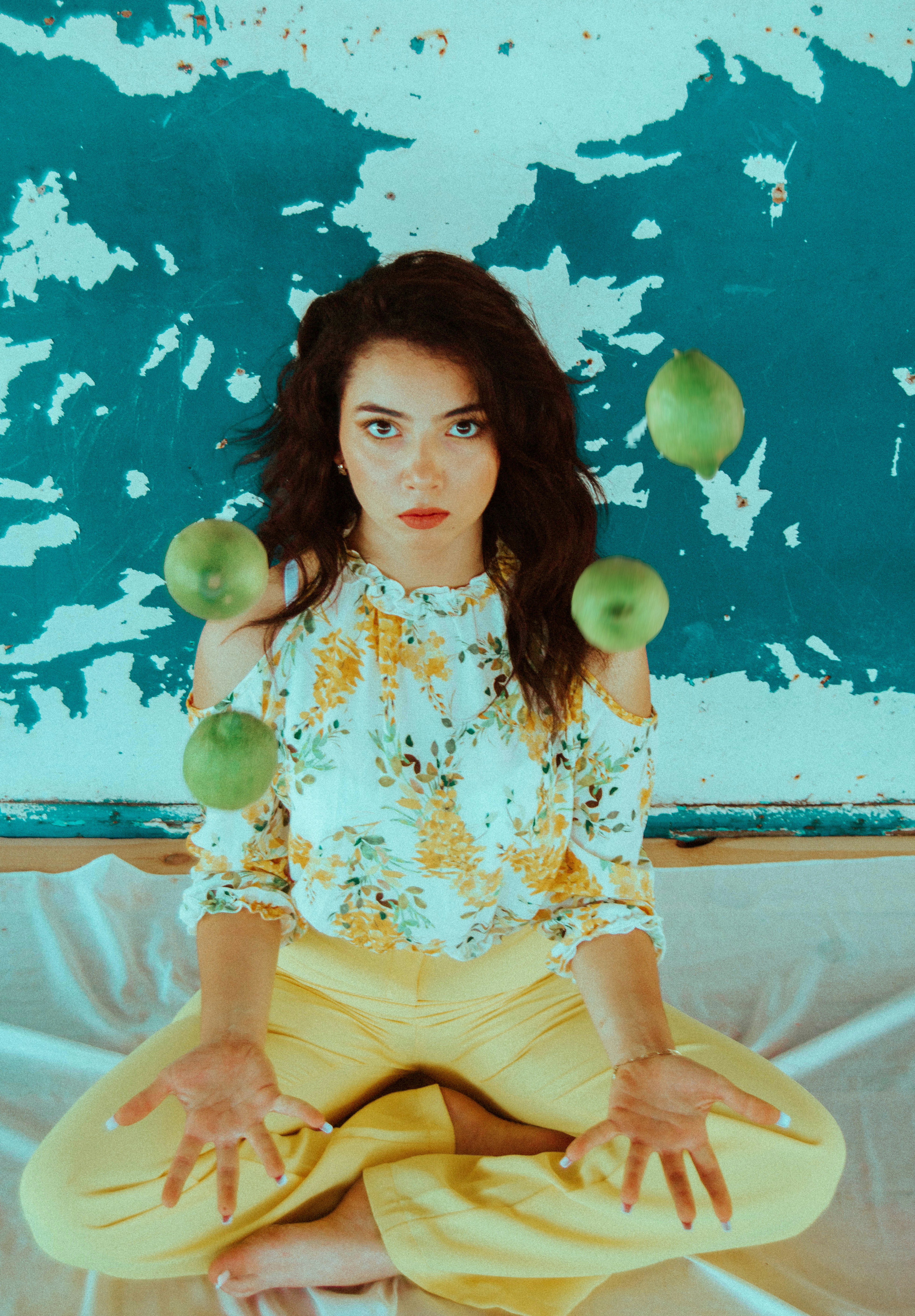 Floating Orbs and a Calm Gaze: A Portrait Above the Wall