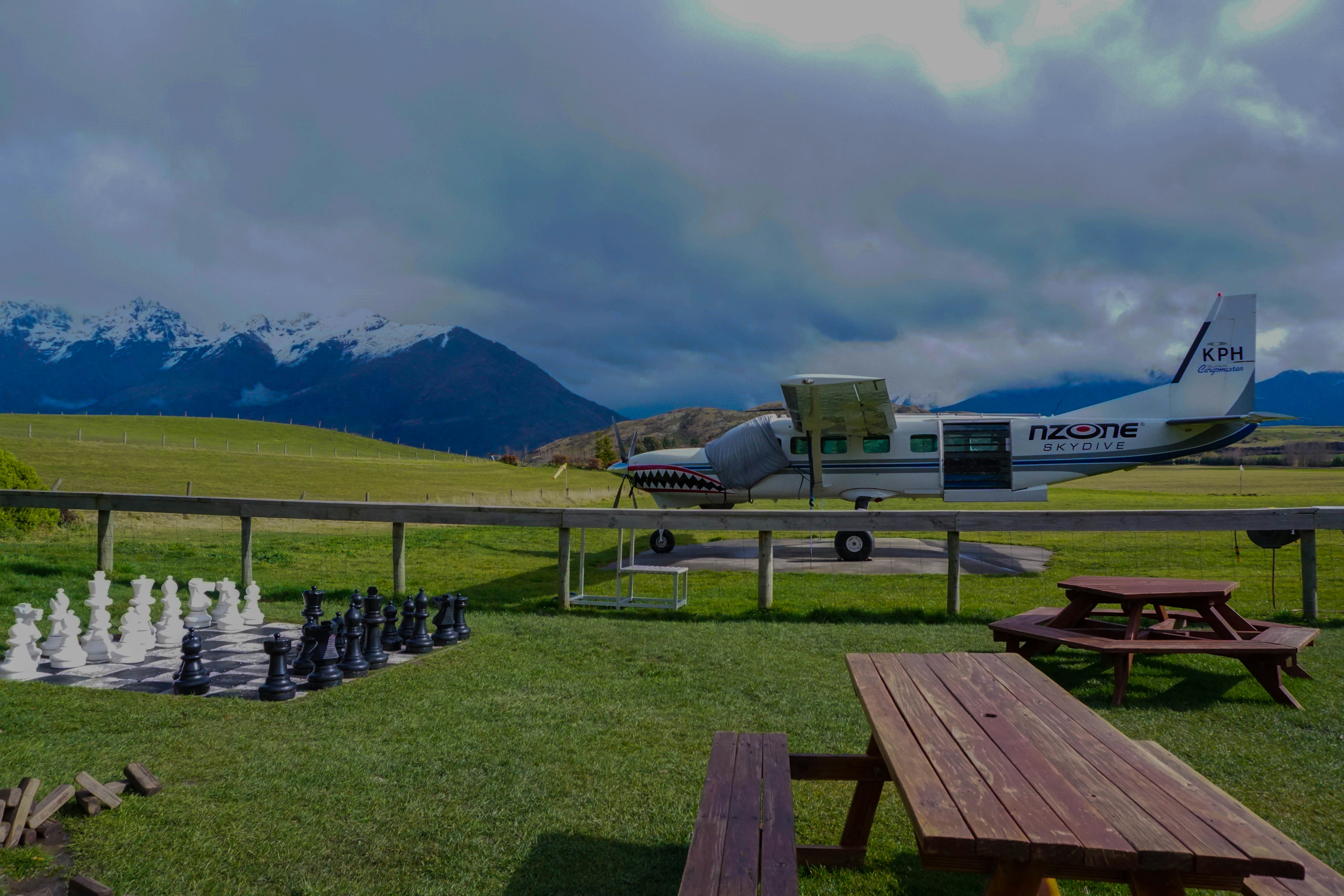 Wings on the Green: A Propeller Plane in a Parkland with Mountain Backdrop