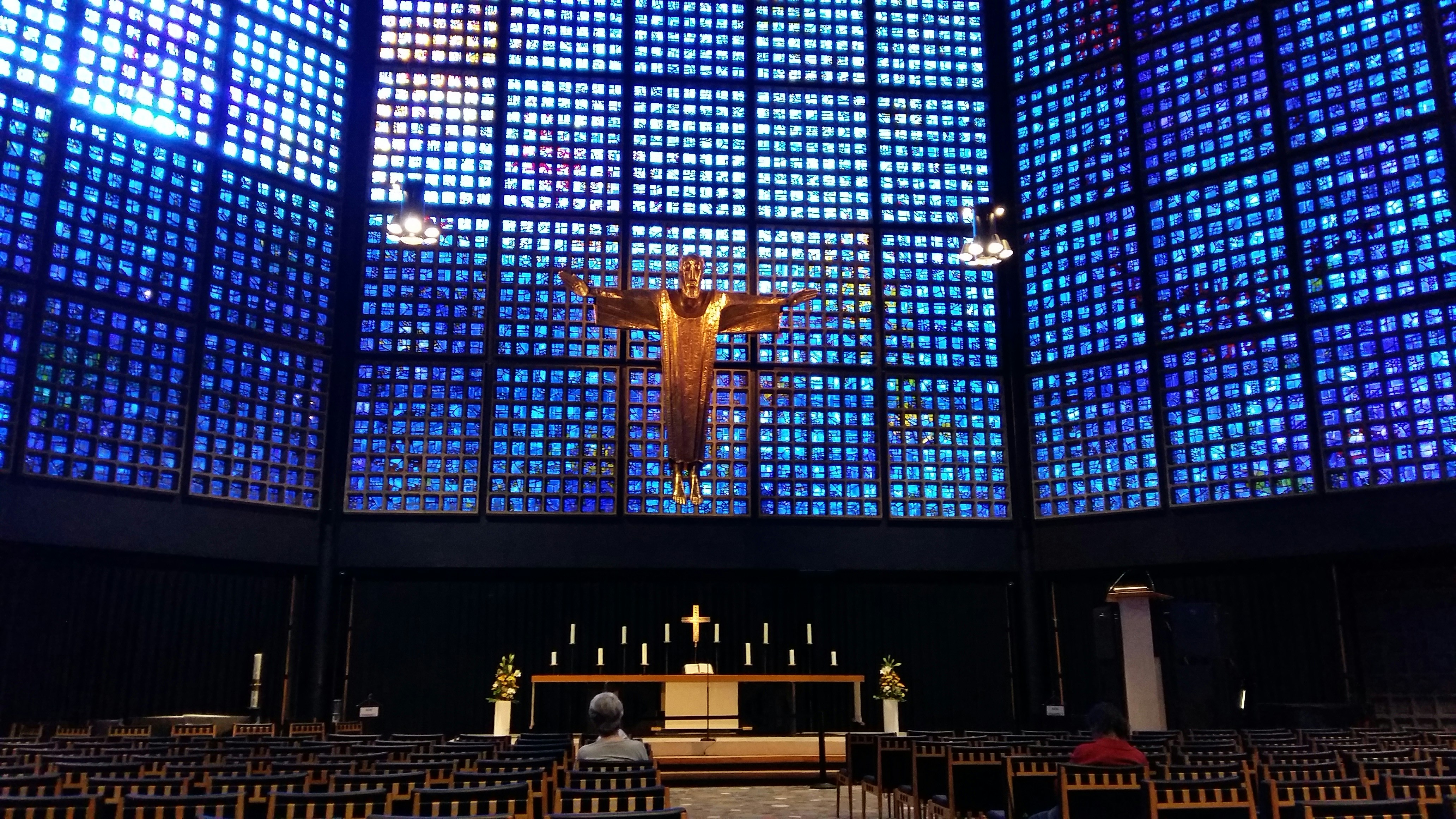 Crucifix Center Stage Beneath a Mosaic of Blue Stained Glass