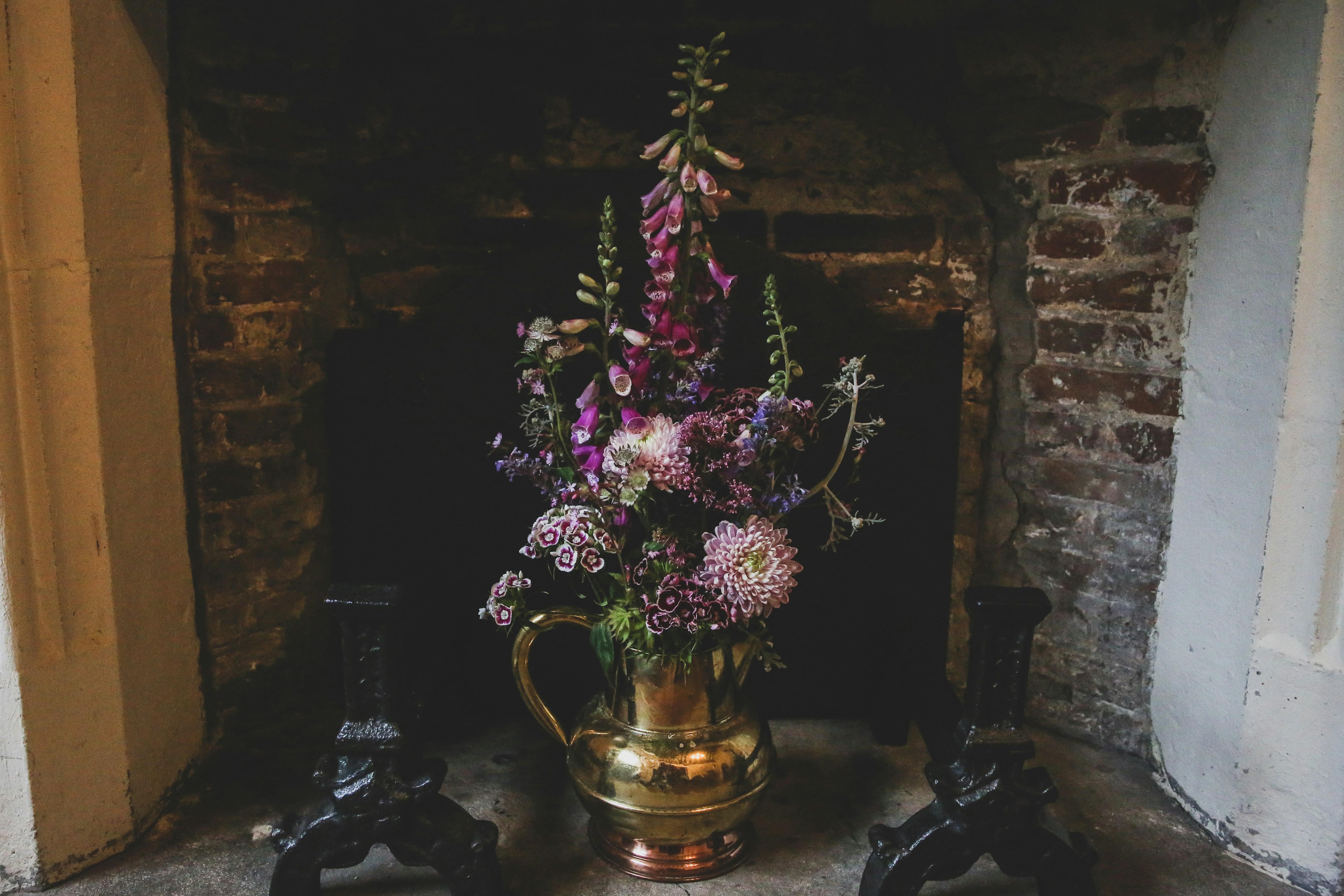 Copper Vase of Evening Blooms in a Stone Niche
