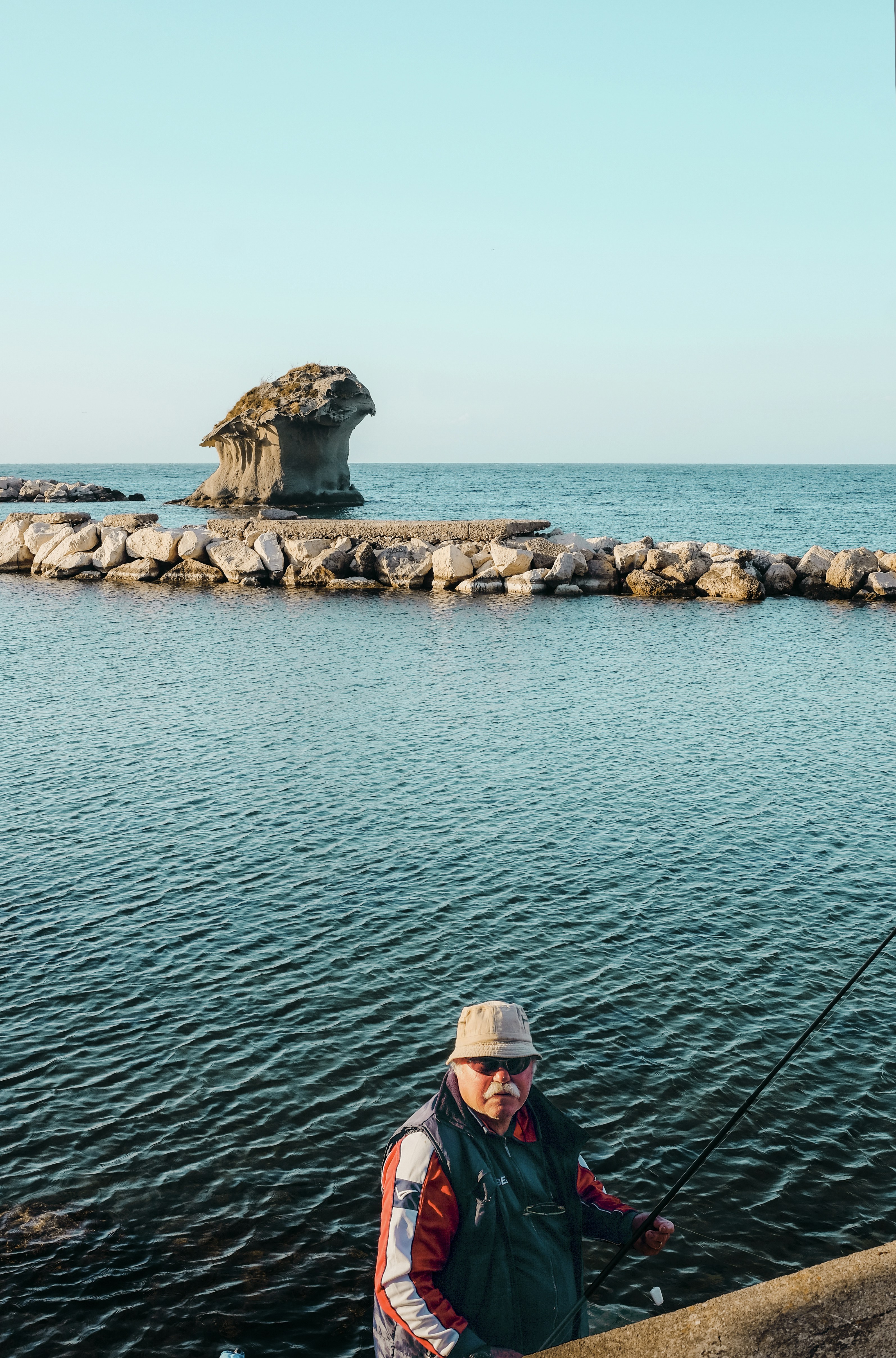 Man beside body of water photo – Free Promontory Image on Unsplash
