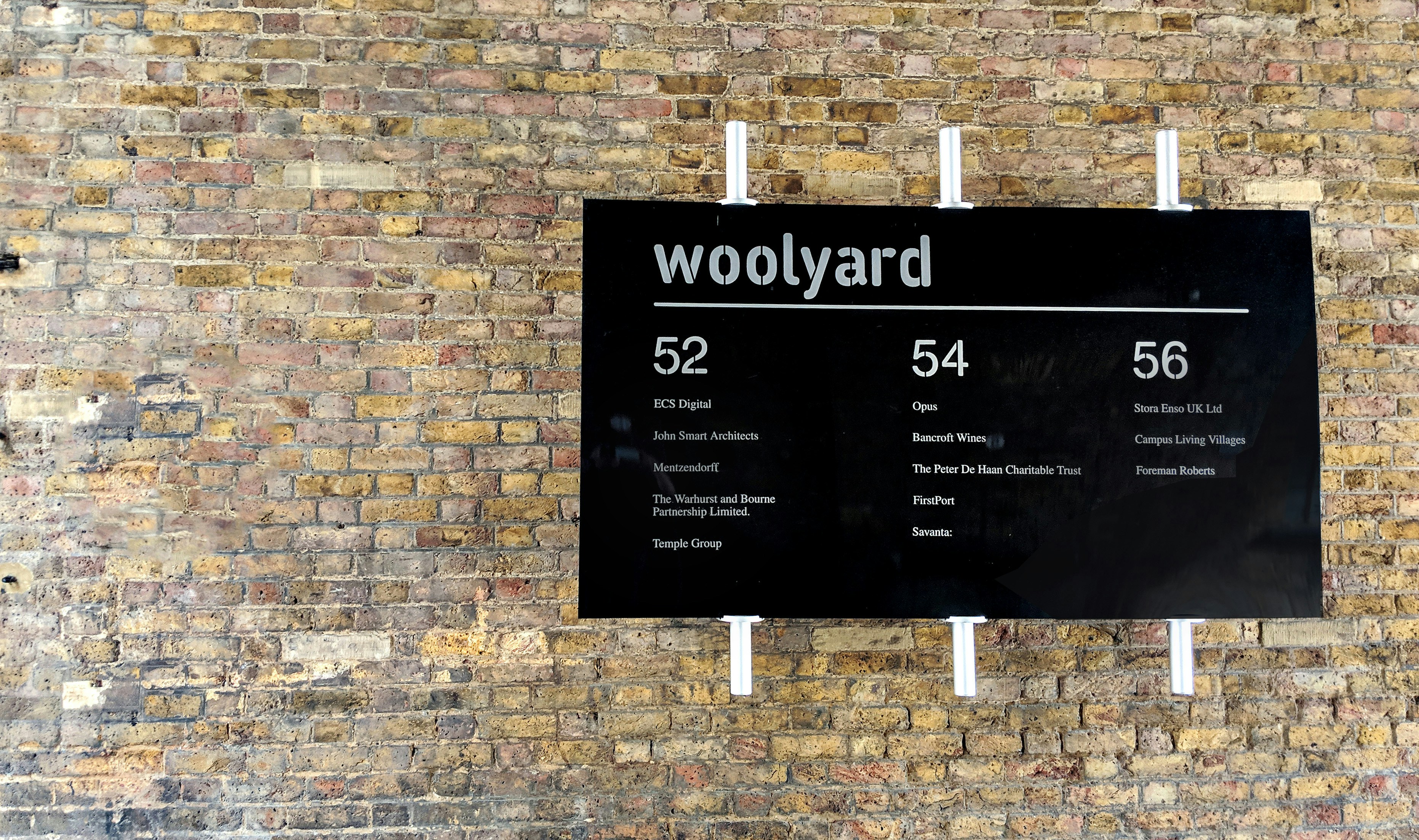 a sign on the side of a brick building