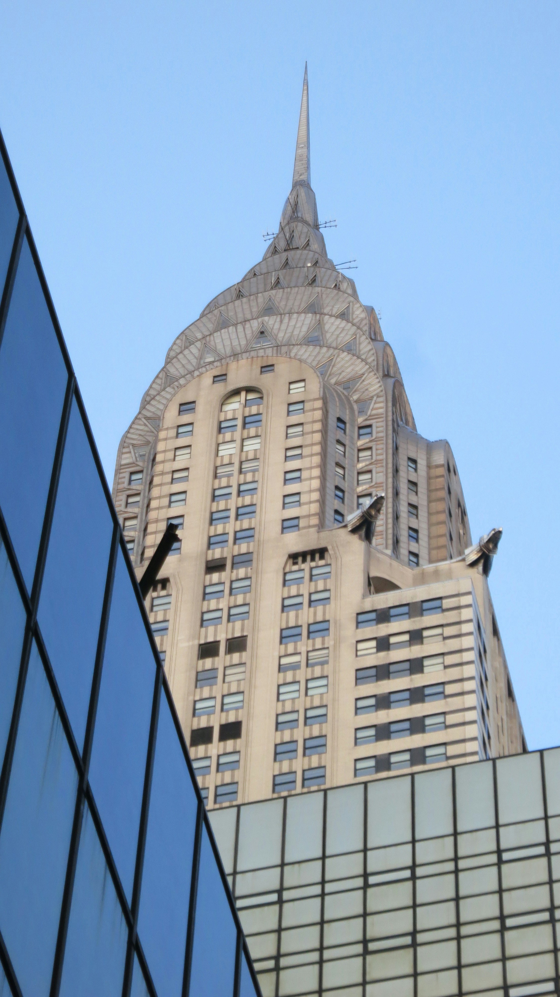 A tall building with a sky scraper in the background photo – Free ...