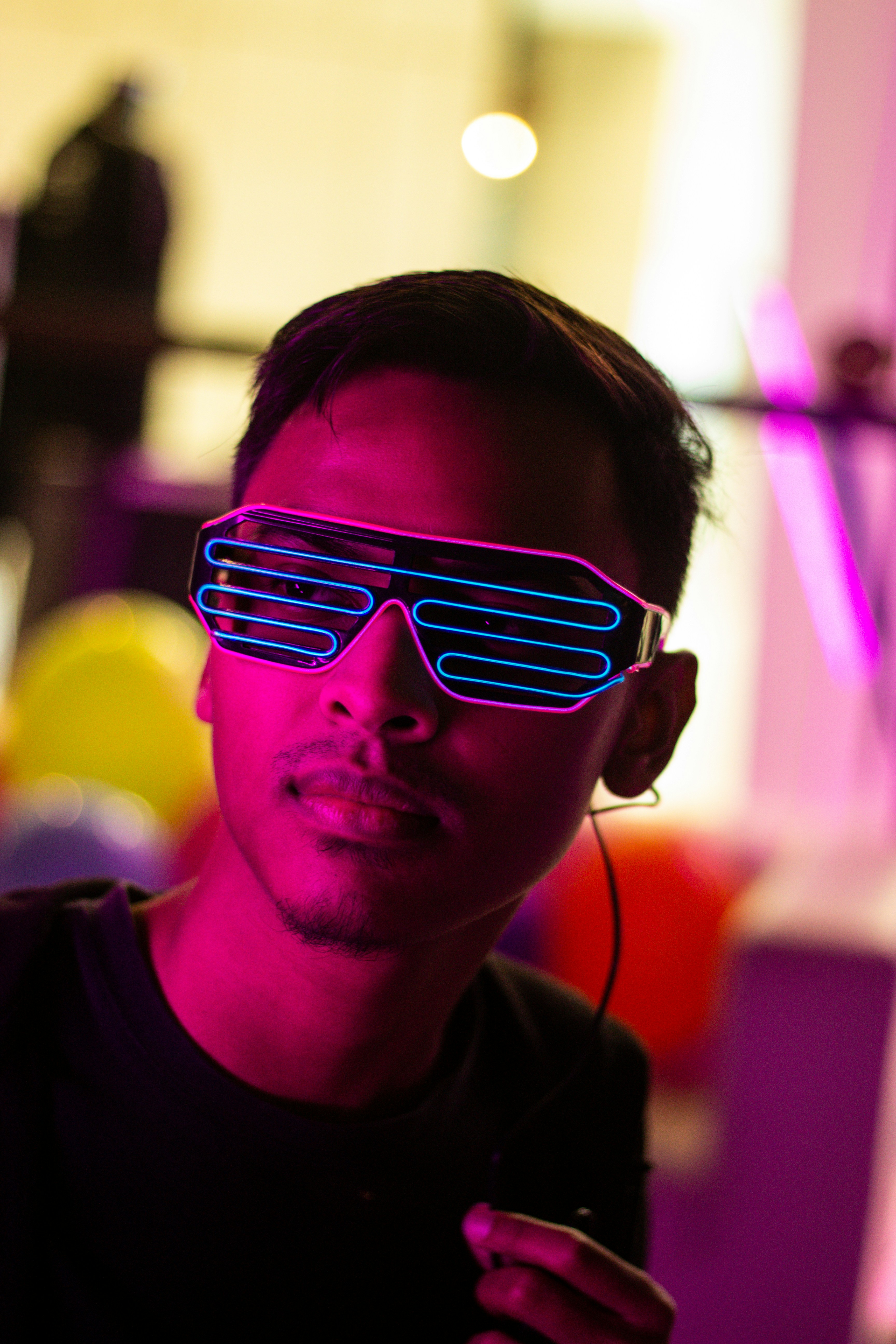 man in black crew neck shirt and LED sunglasses