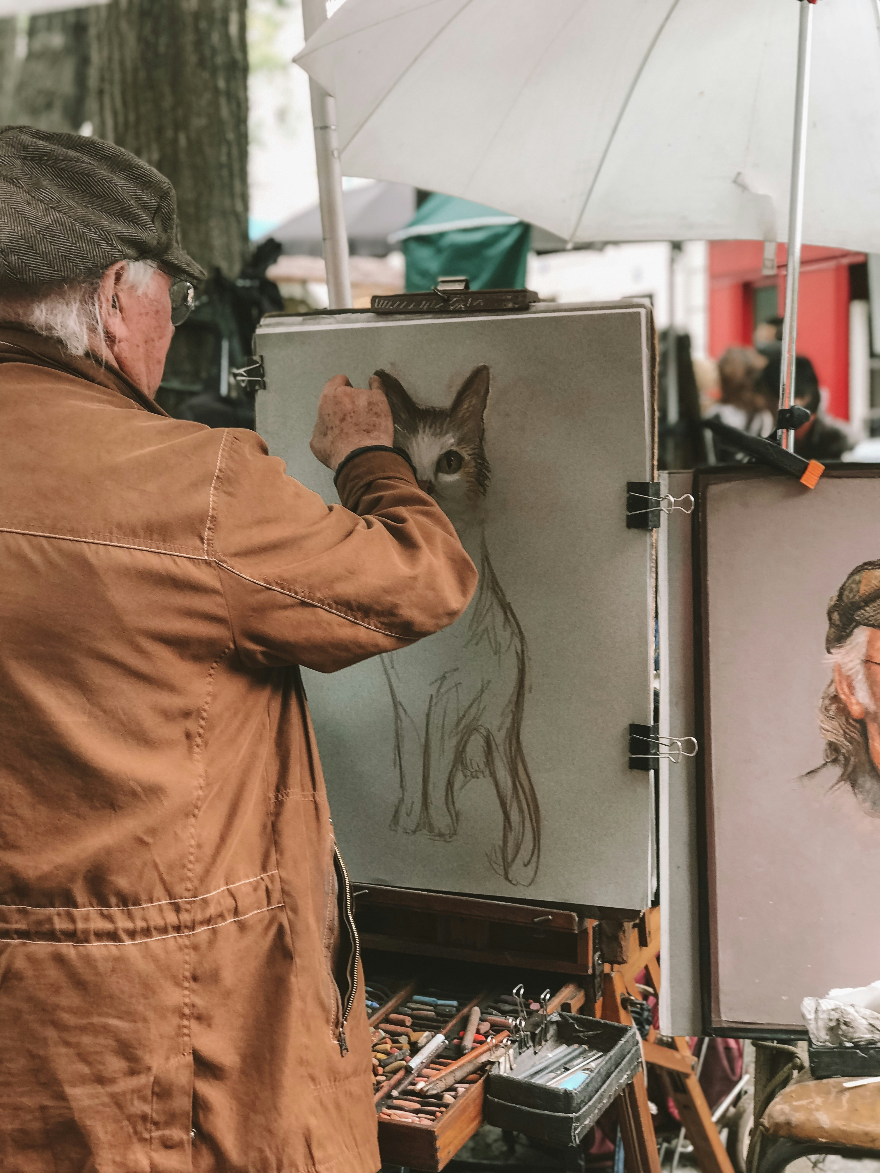 Market Sketch: A Street Artist Shapes a Dog on a Portable Easel