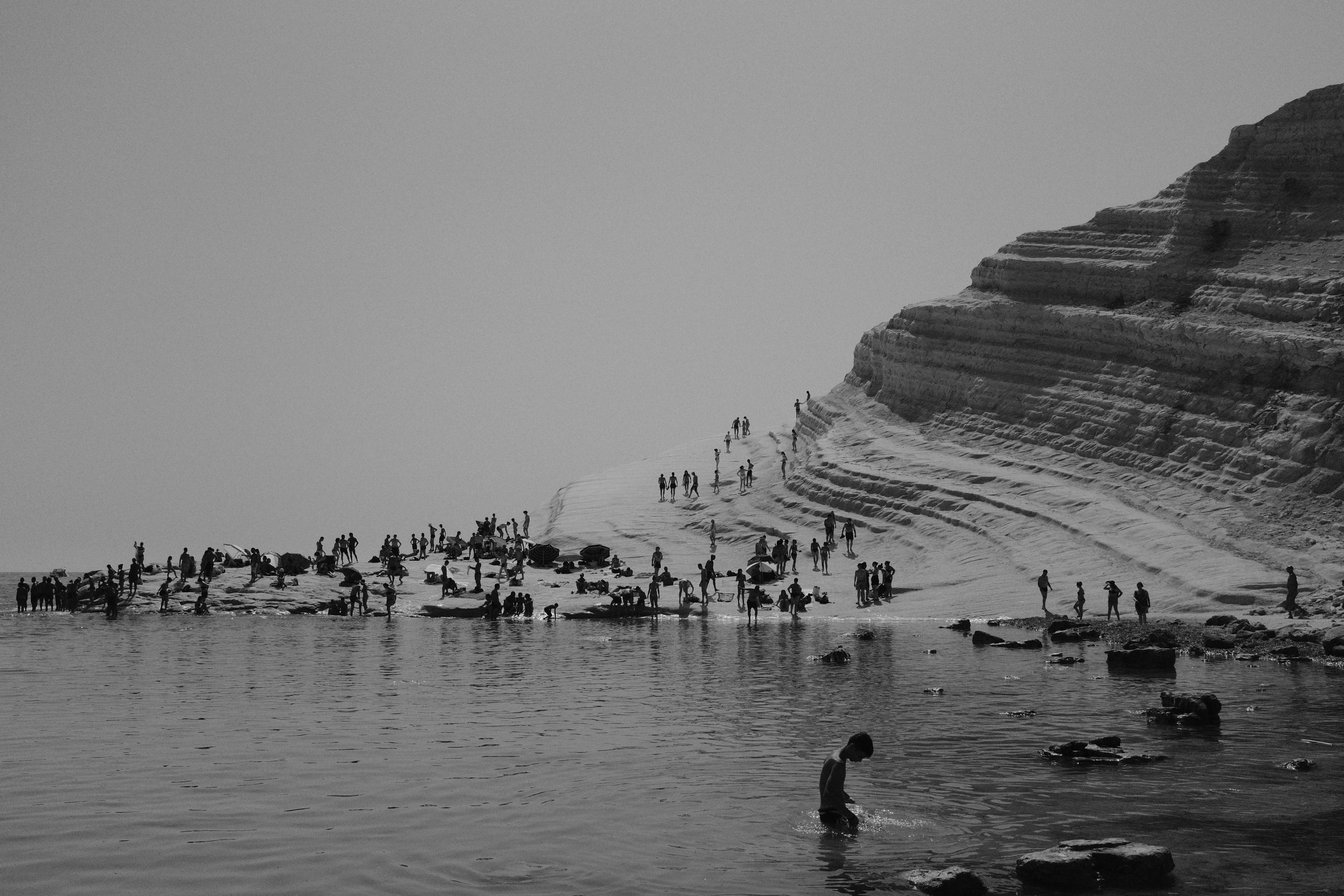 Grayscale photo of a crowd on a beach photo – Free Nature Image on Unsplash