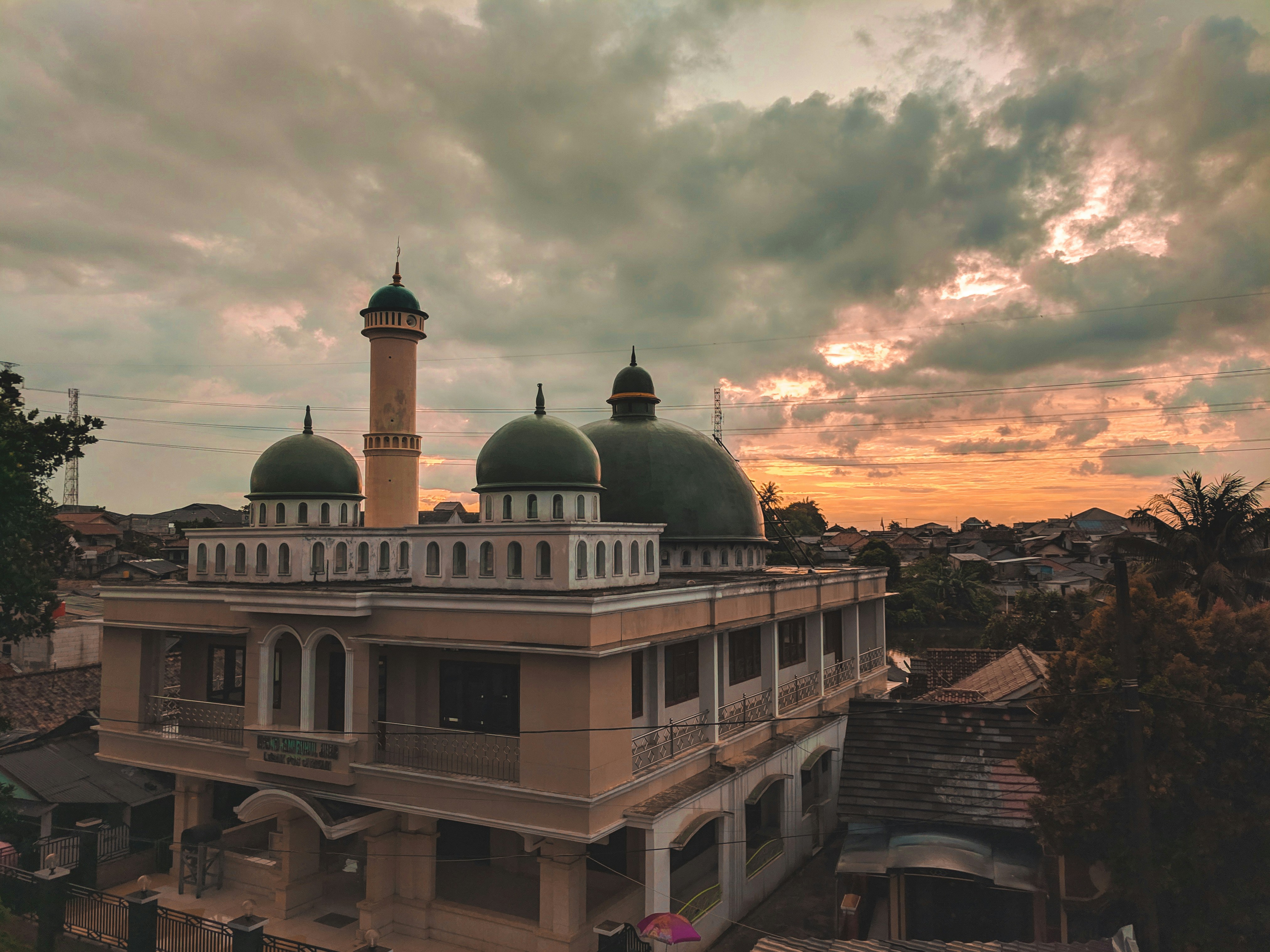 Dusk Over a Palm-Fringed, Multi-Dome Mosque Above the Neighborhood
