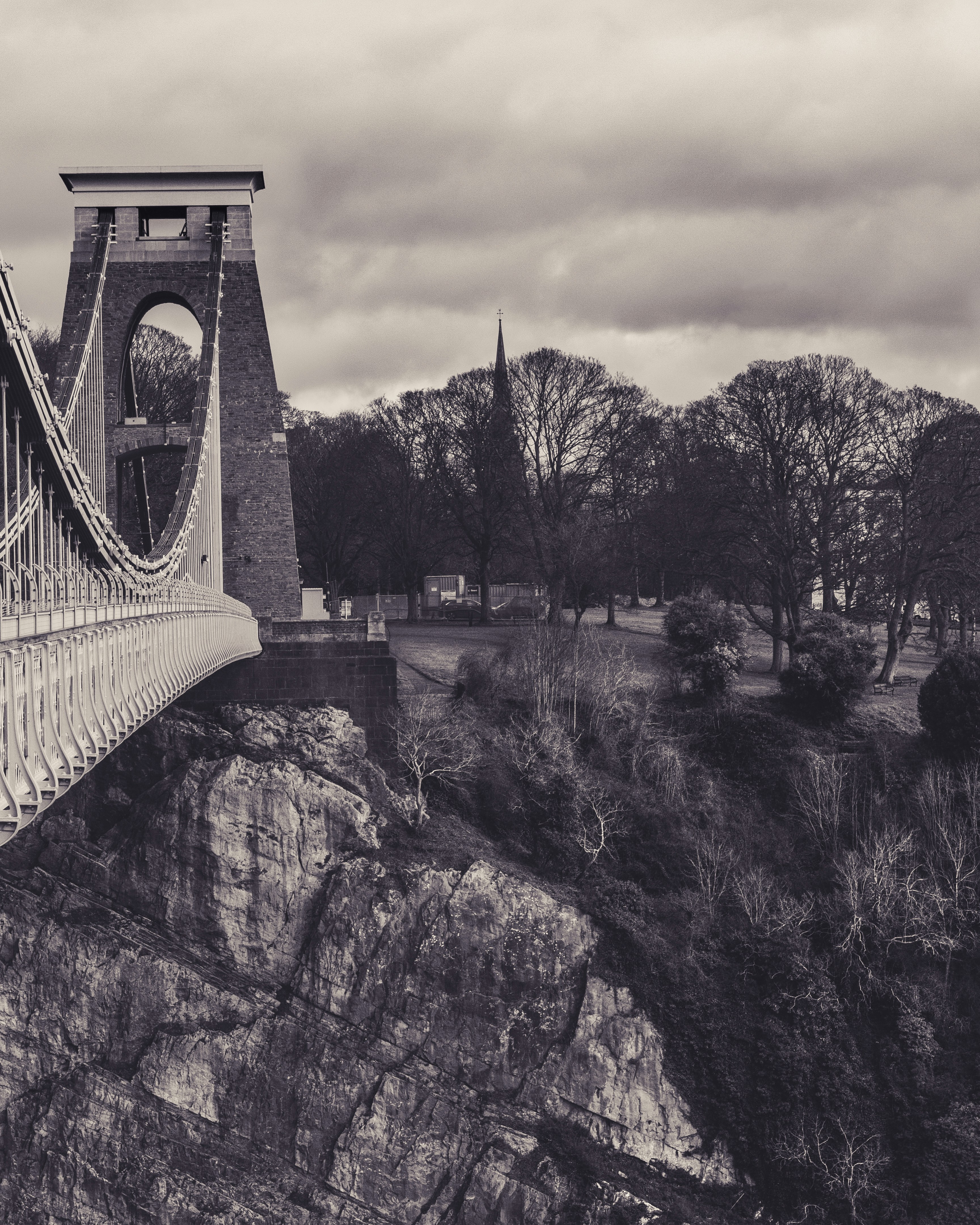Granite Veins and Steel Arc: A Suspension Bridge at Dusk