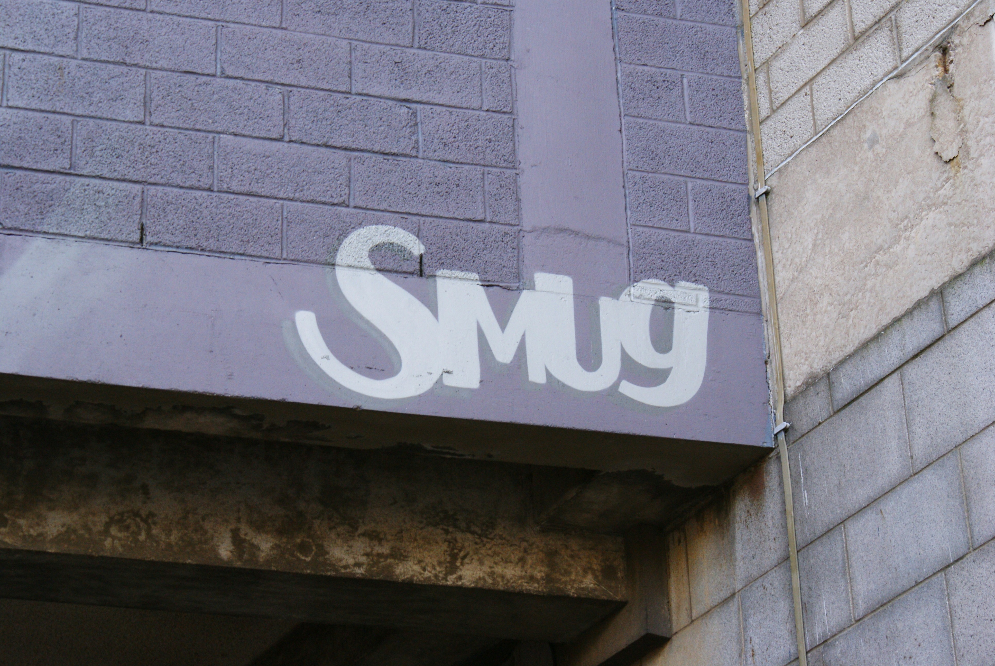 Smug text on wall photo – Free Grey Image on Unsplash