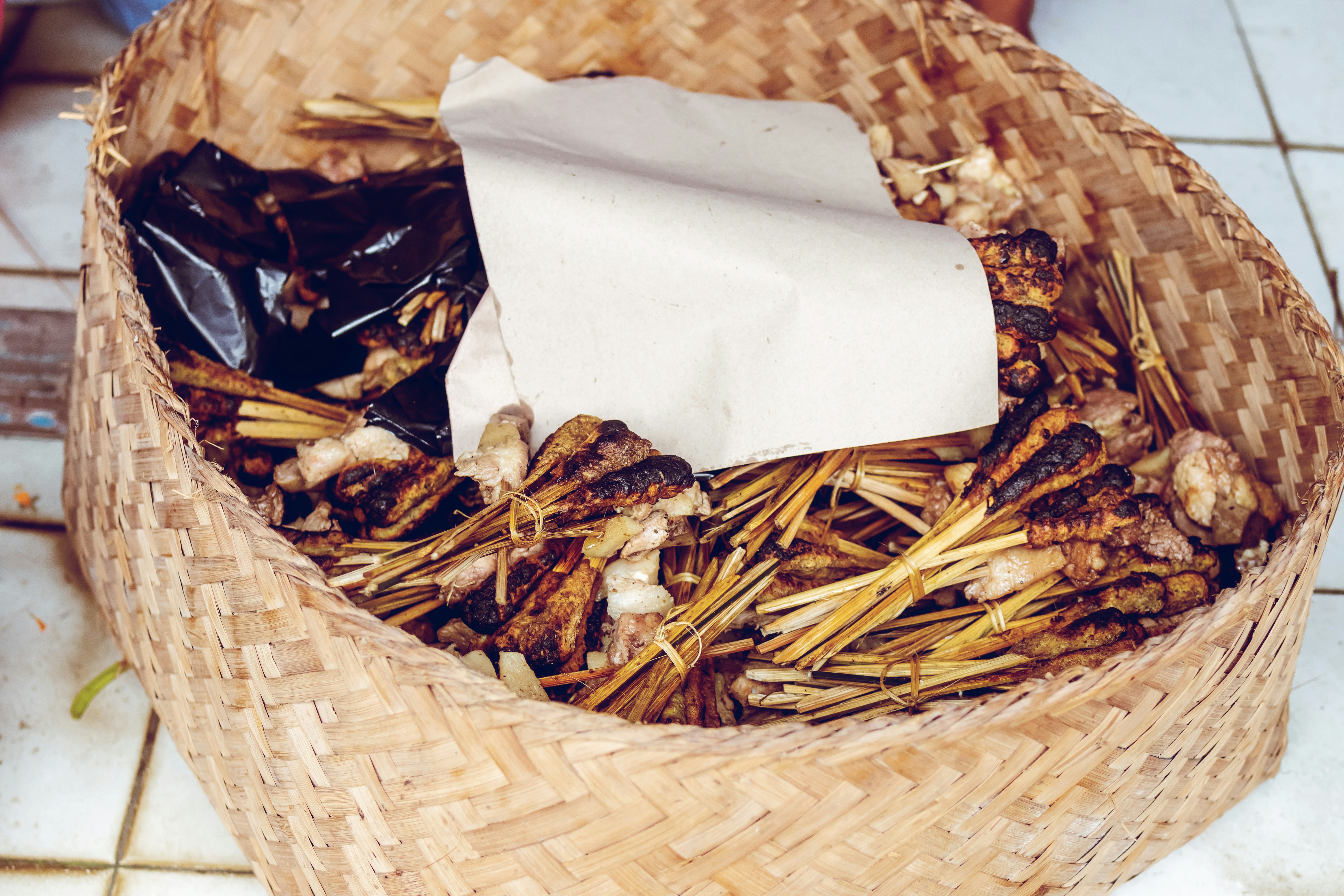 Crumpled Paper in a Woven Basket Among Dried Stalk Debris