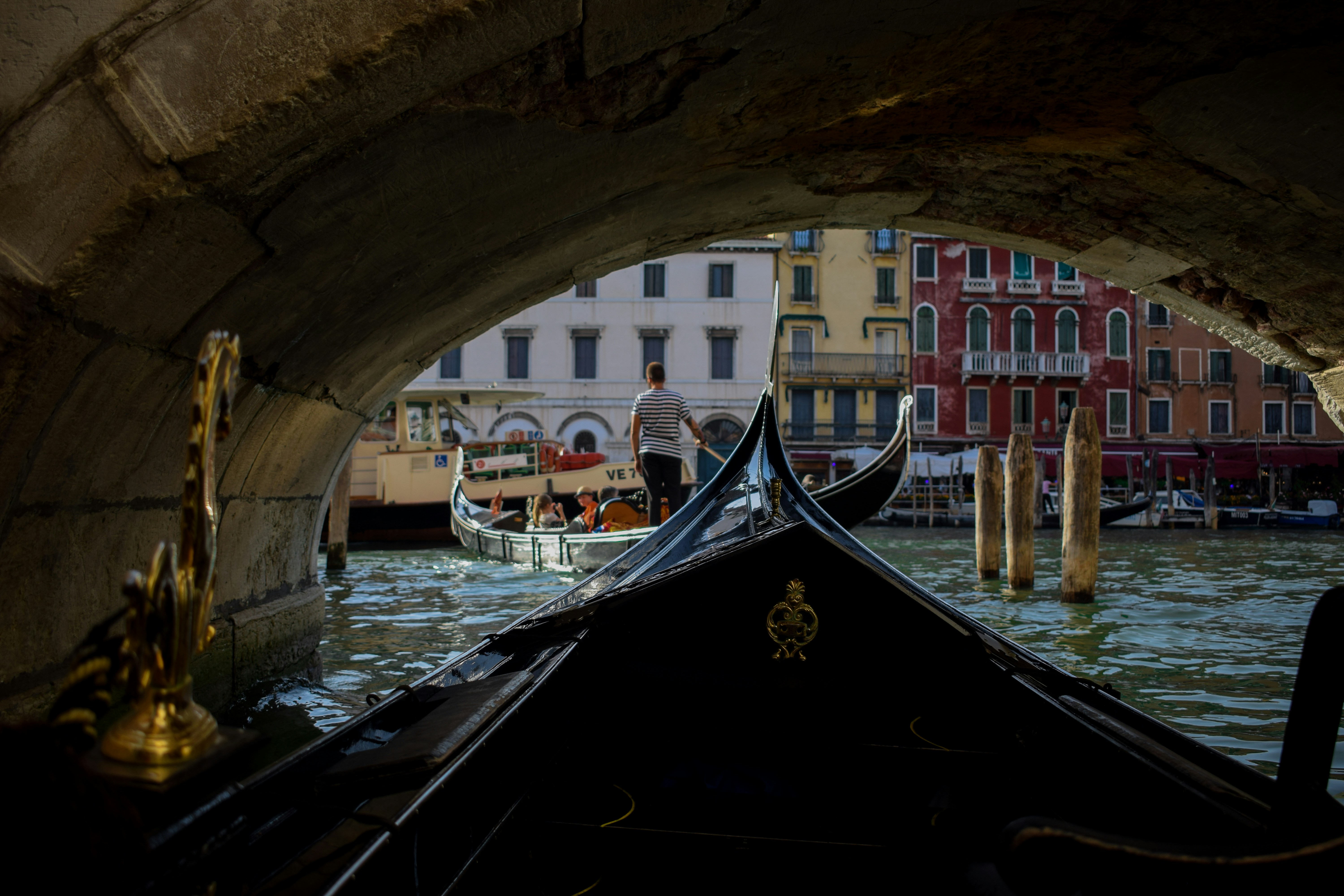 Bow View Through a Venetian Arch: Gondola Drift toward Sunlit Facades