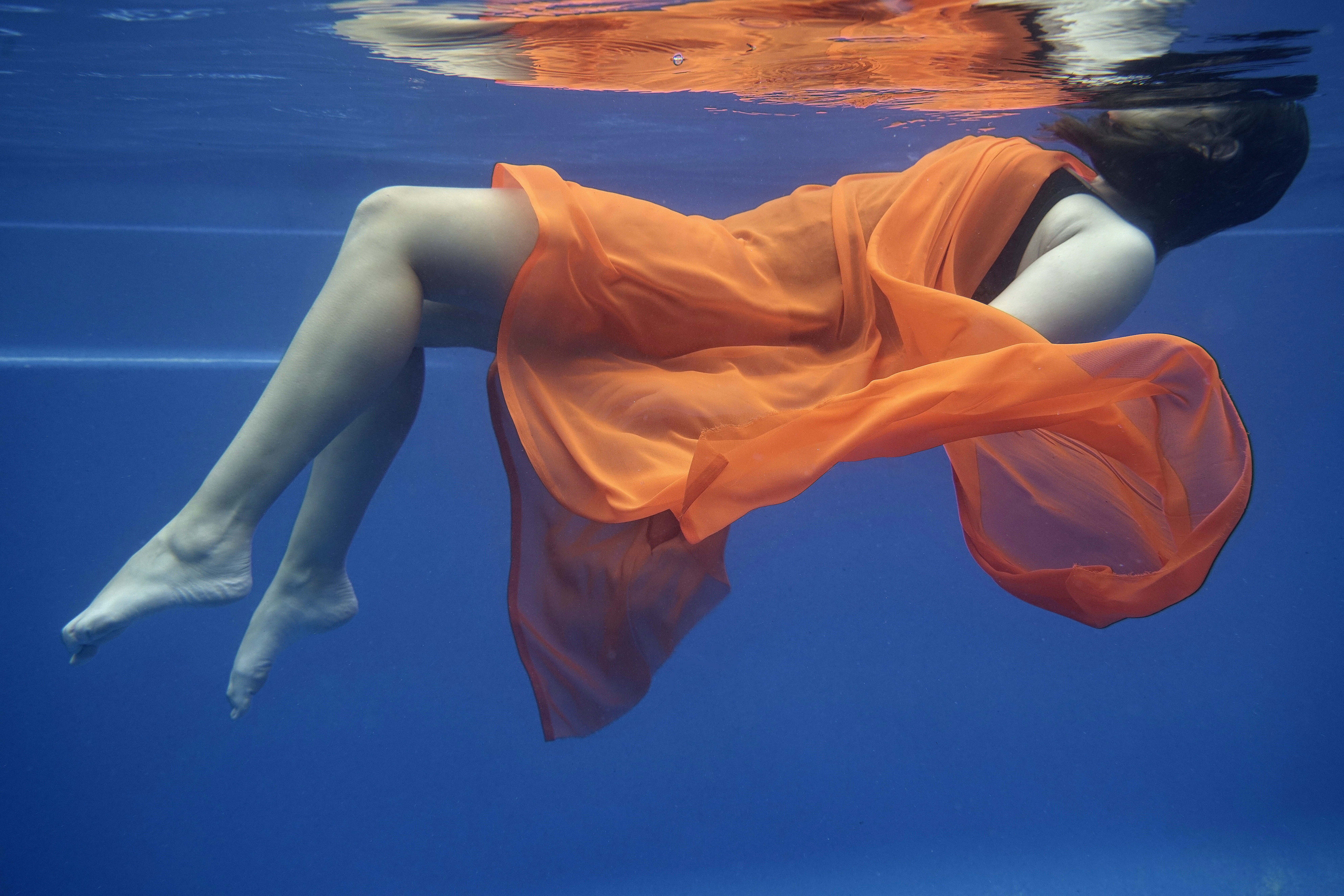 woman floating on body of water