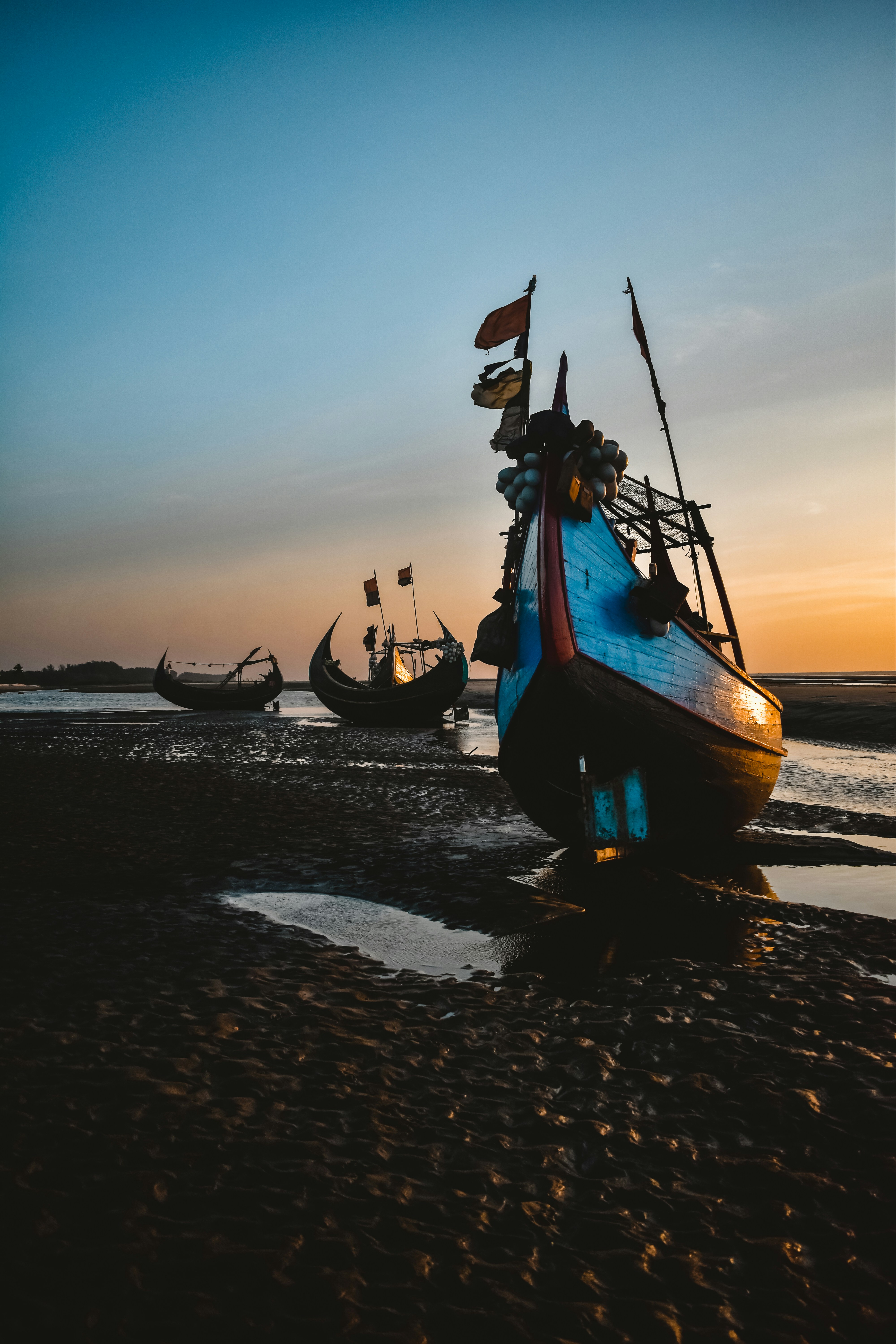 Low-angle photography of three boats by the seashore photo – Free ...