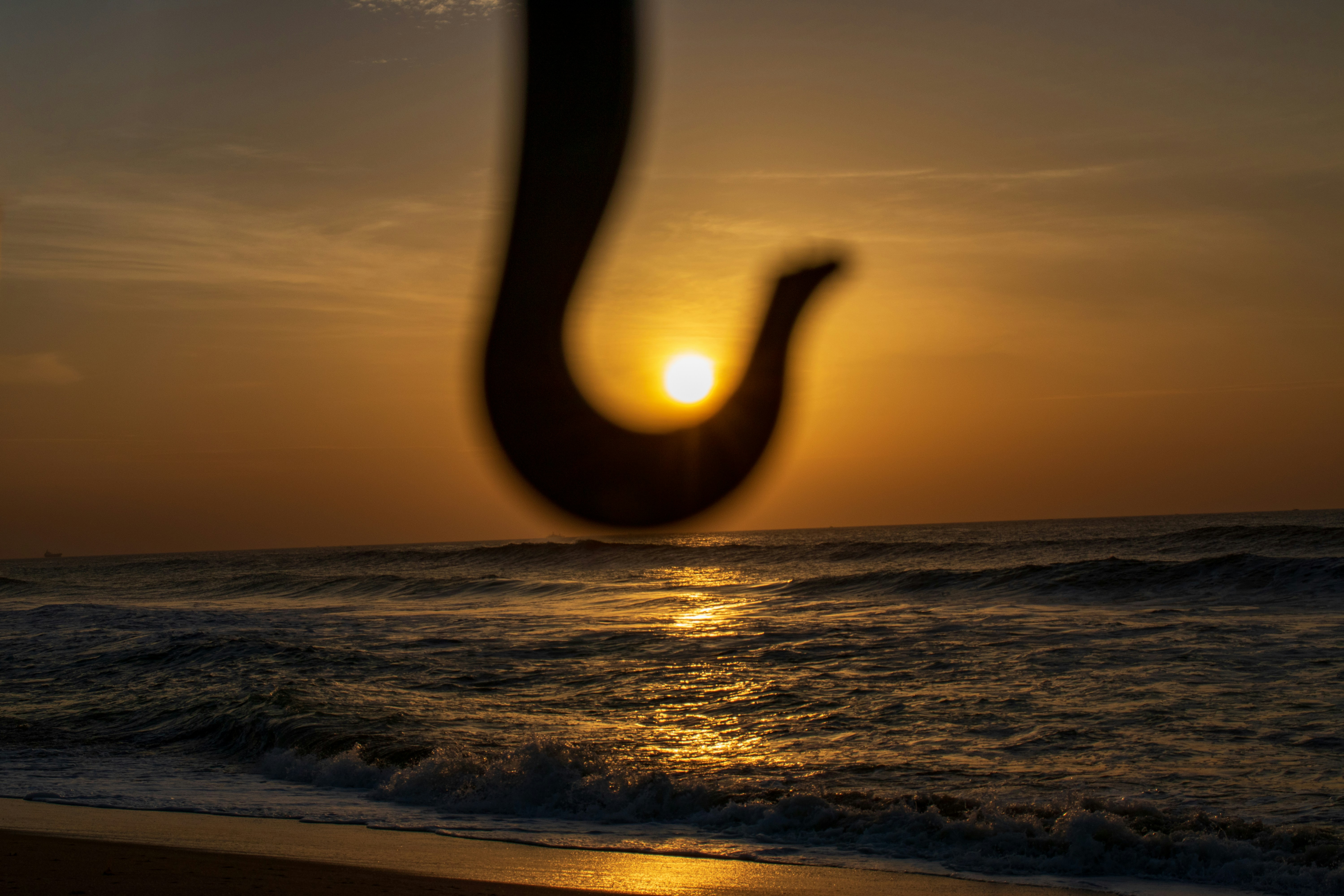 Hooked on Sunset: A Floating Foreground Silhouette Framing the Sun